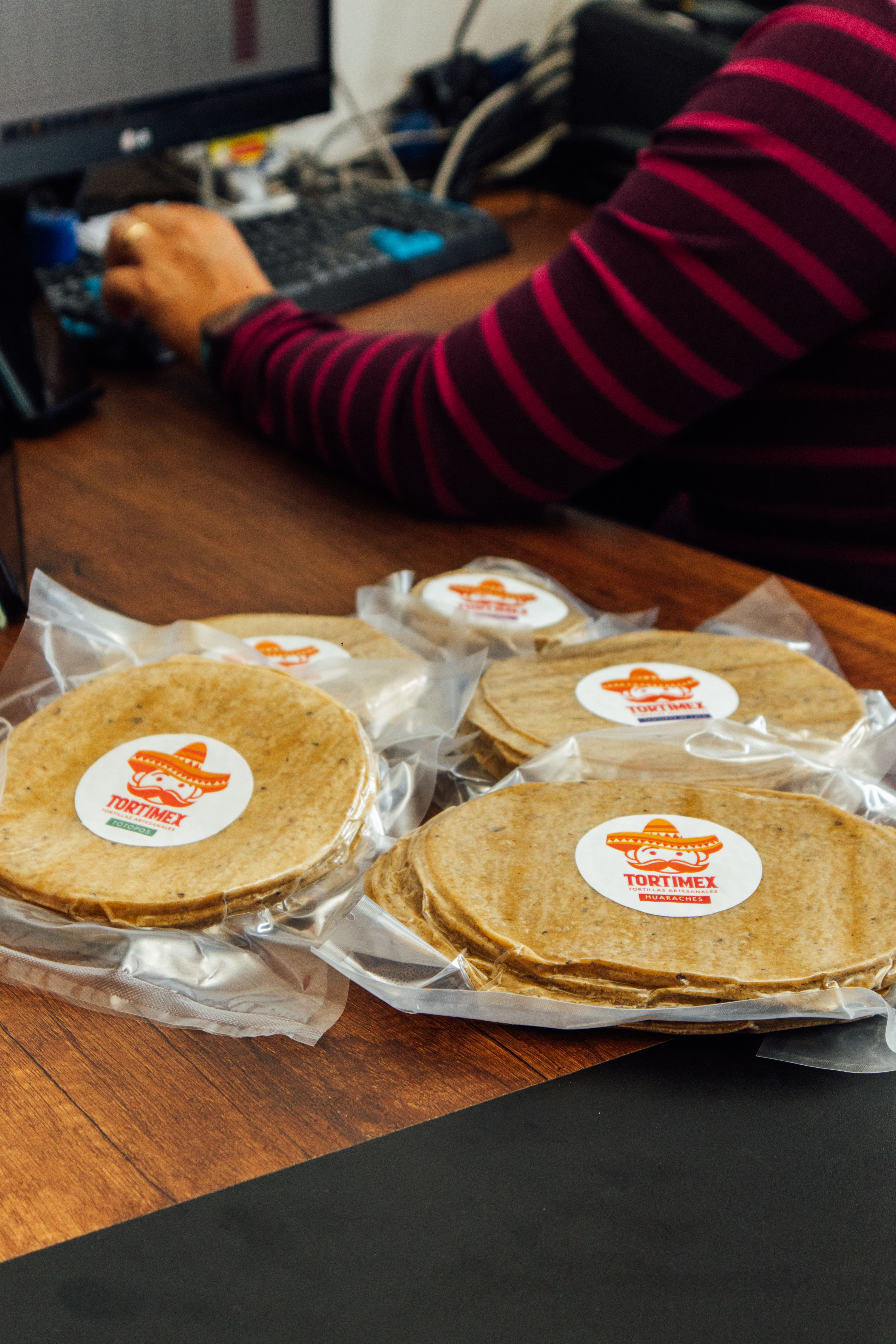 Packaged Tortillas on Office Desk in Vibrant Setting · Free Stock Photo