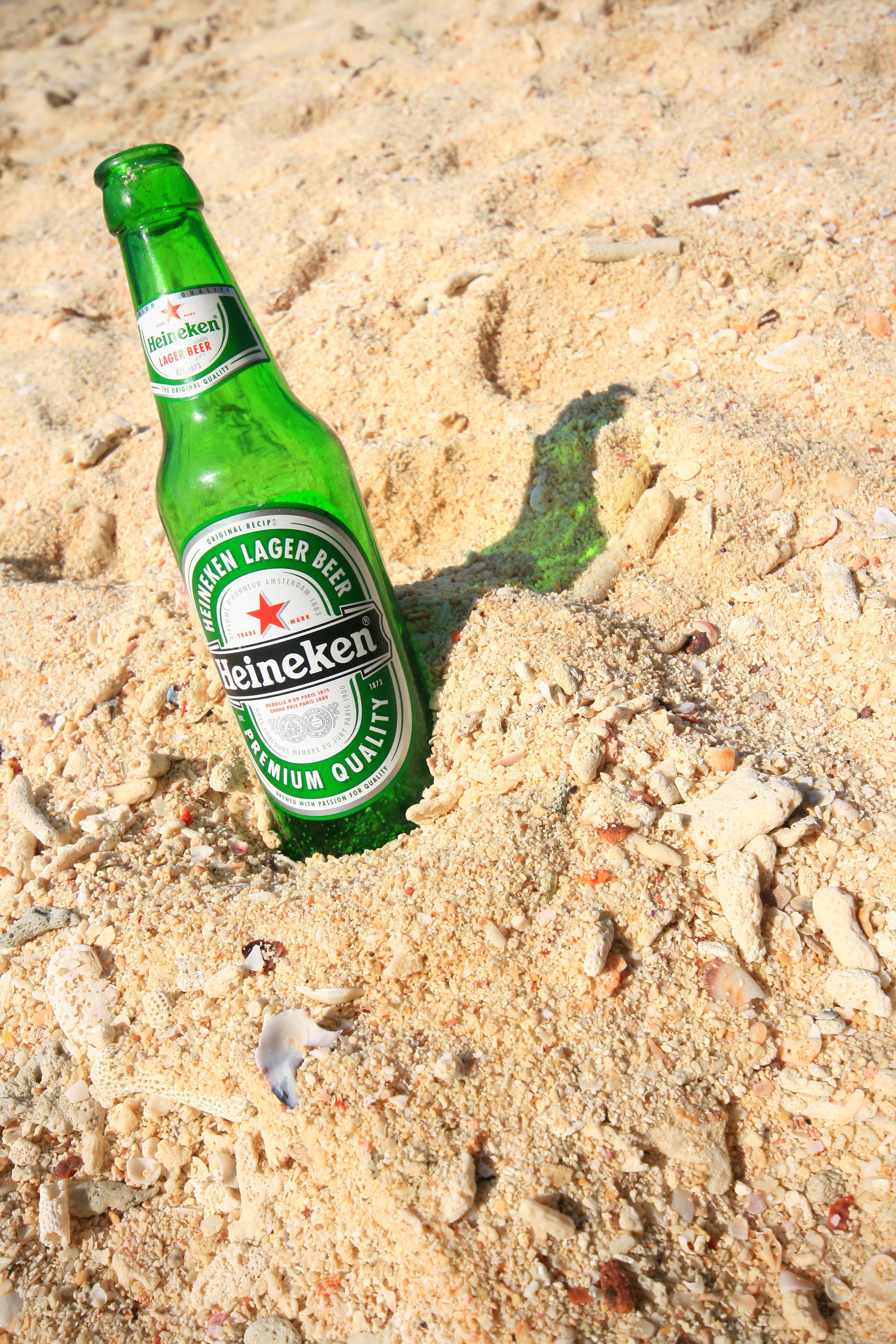 Heineken Beer Bottle on Vietnamese Beach Sand · Free Stock Photo
