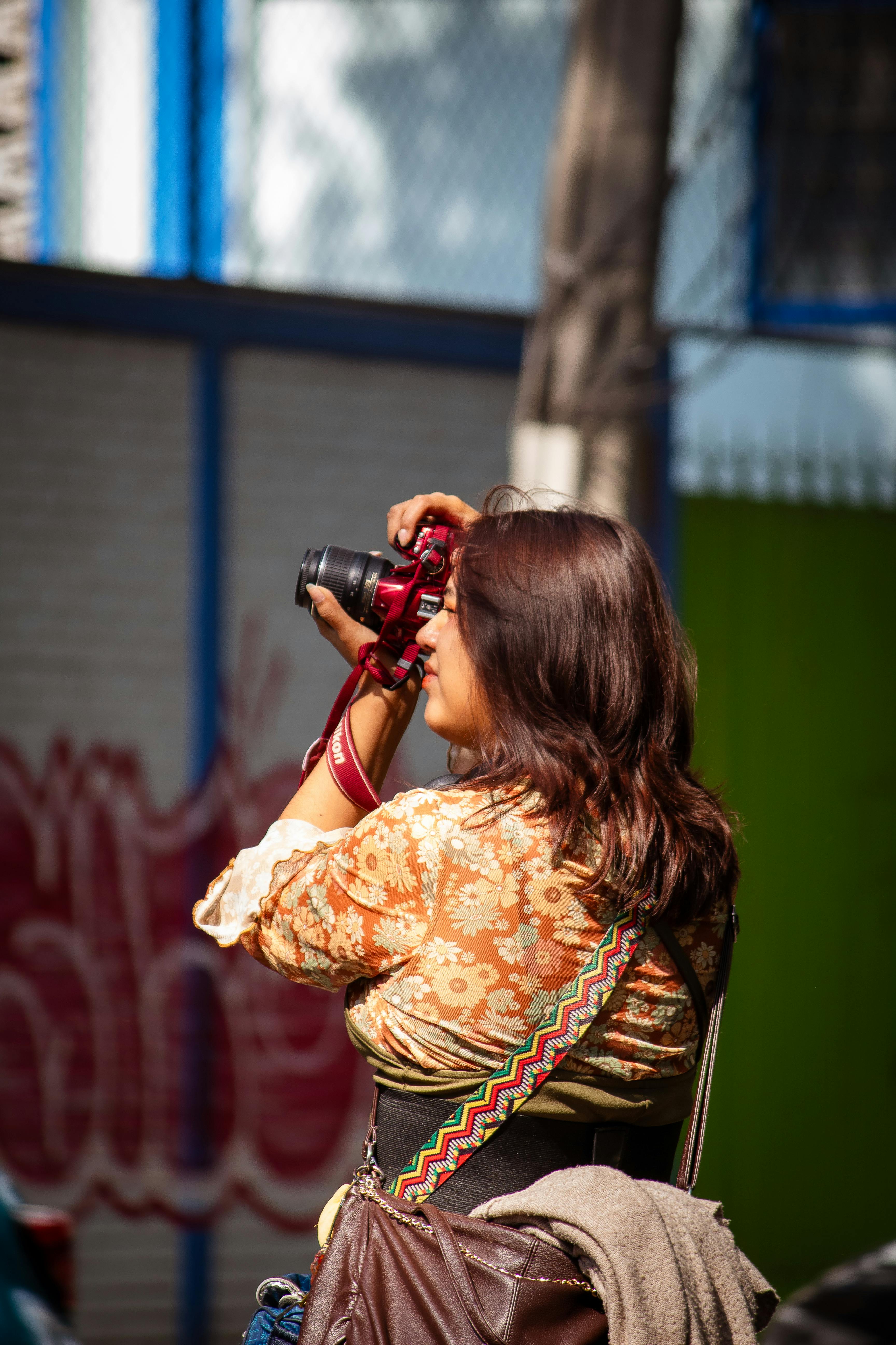 Woman Photographer Capturing Urban Scenes in Mexico City · Free Stock Photo