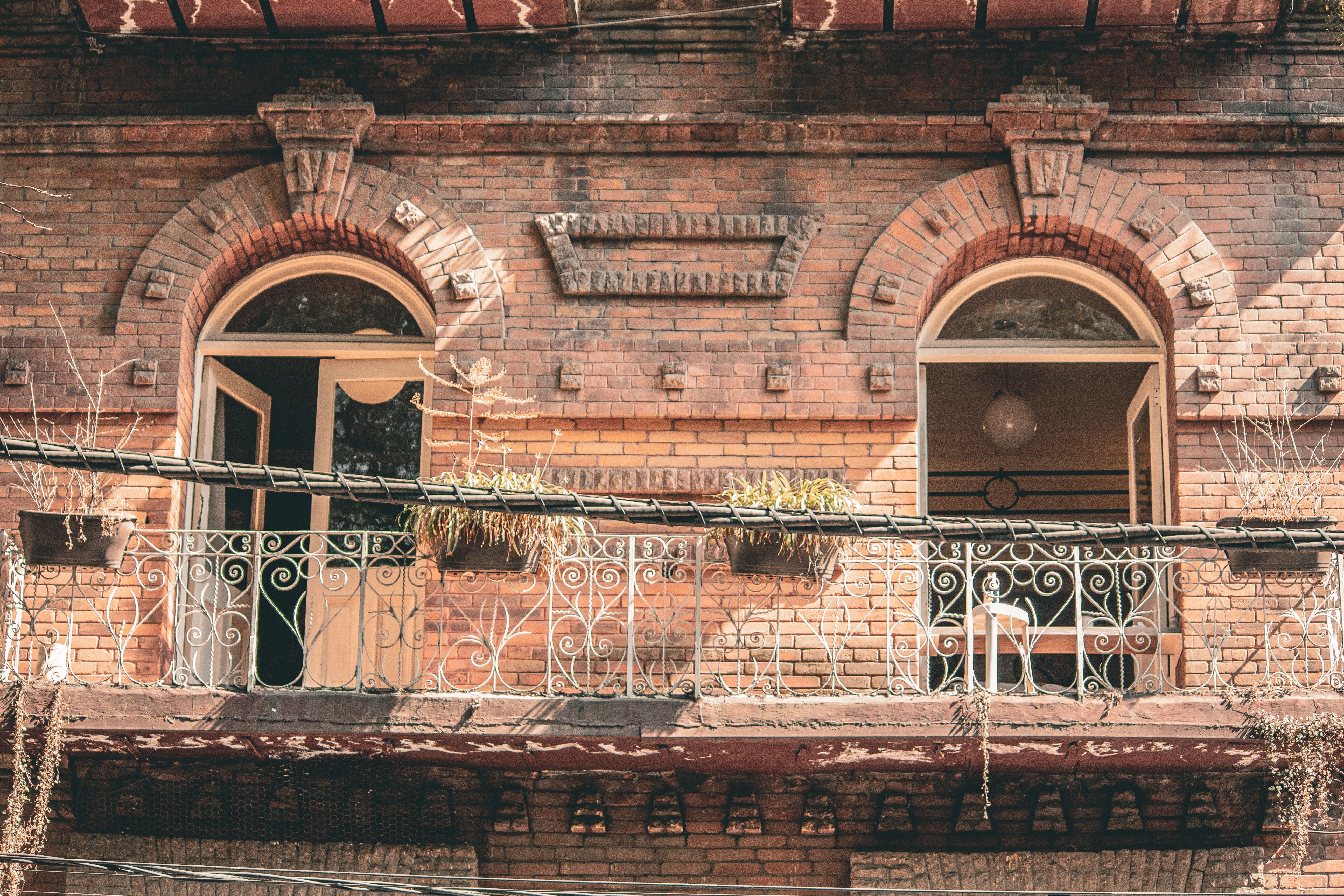 Historic Brick Building with Ornate Balconies · Free Stock Photo