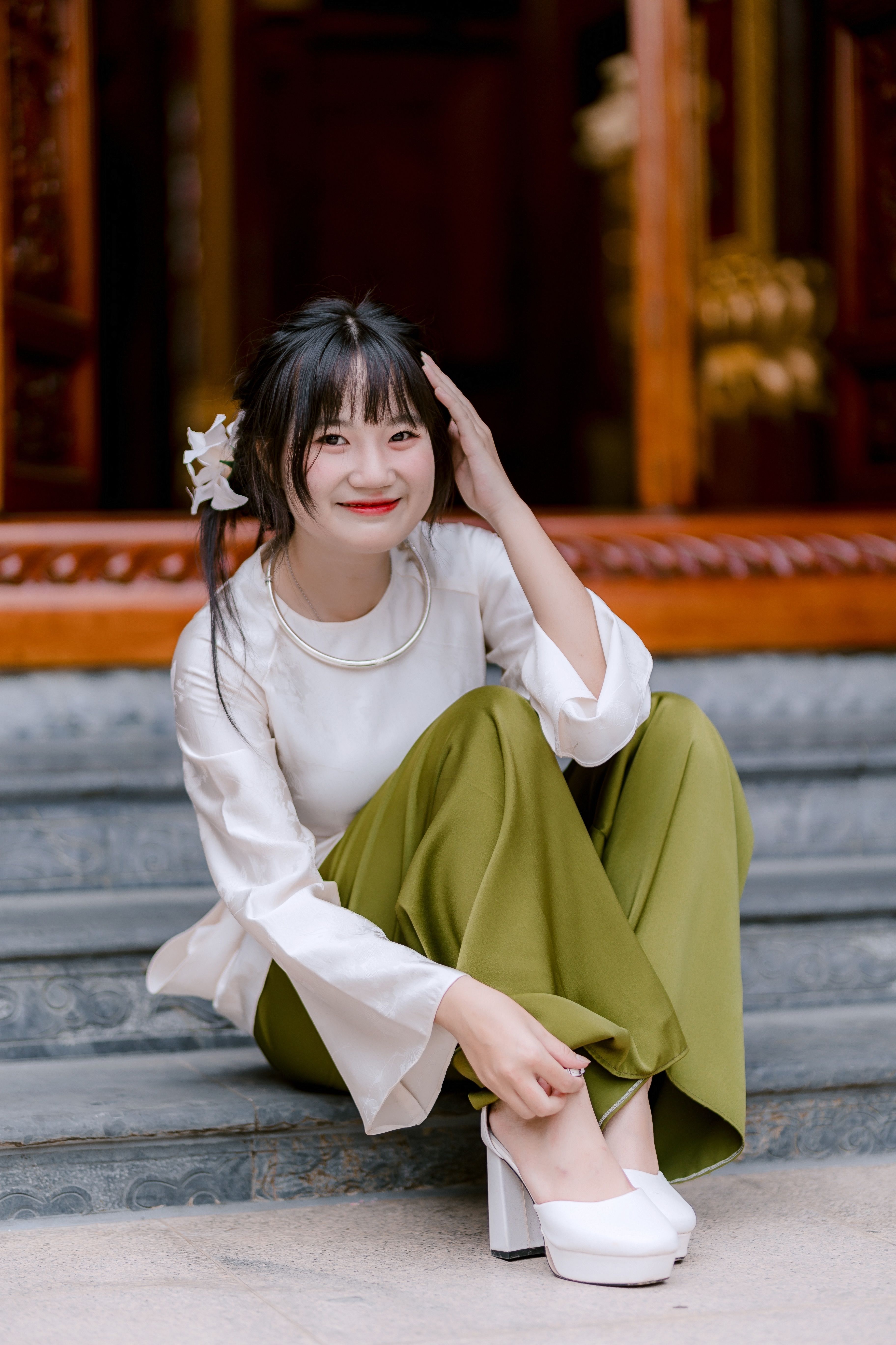 Young Woman Sitting on Steps in Stylish Outfit · Free Stock Photo
