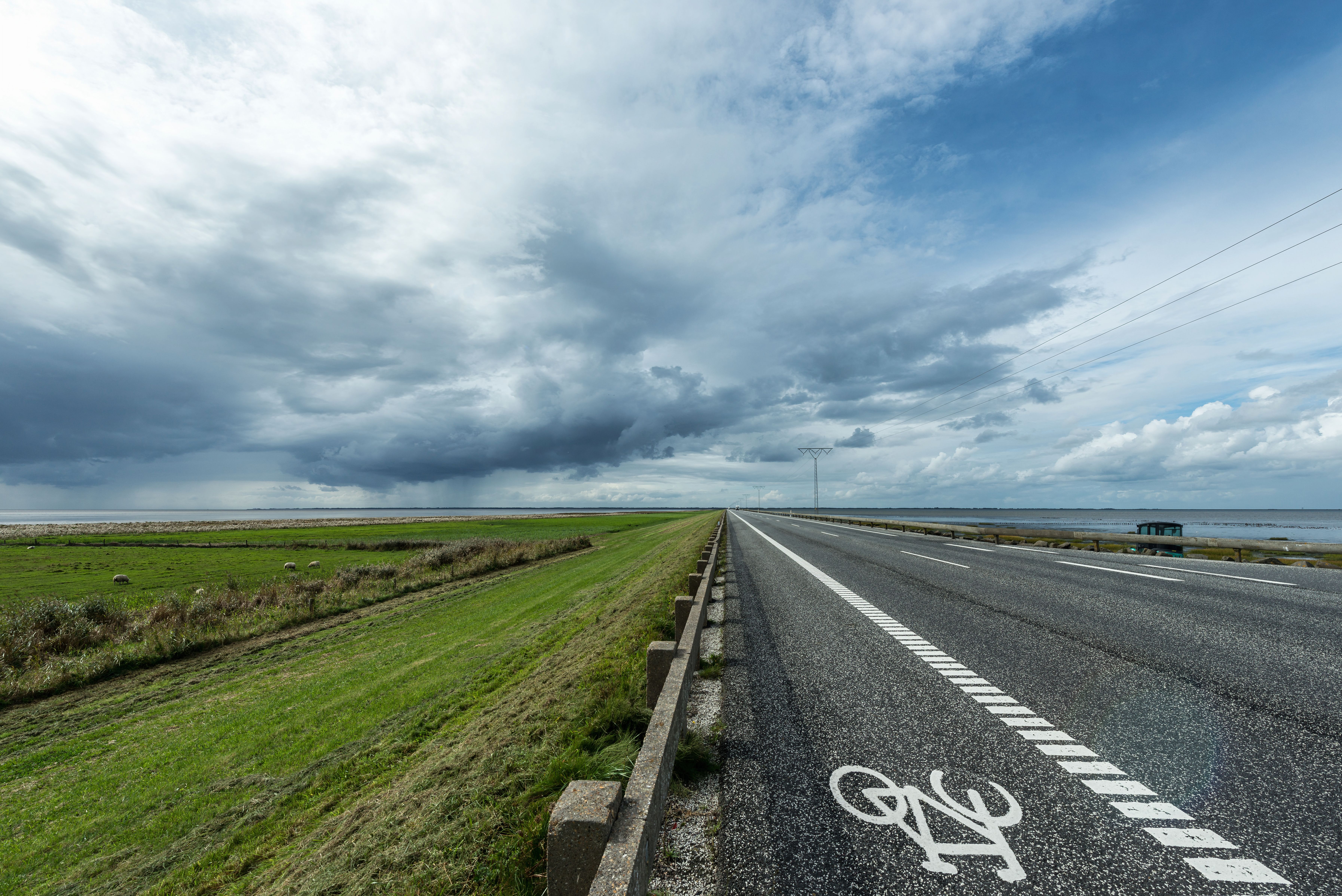 Scenic Coastal Road in Denmark with Dramatic Sky · Free Stock Photo
