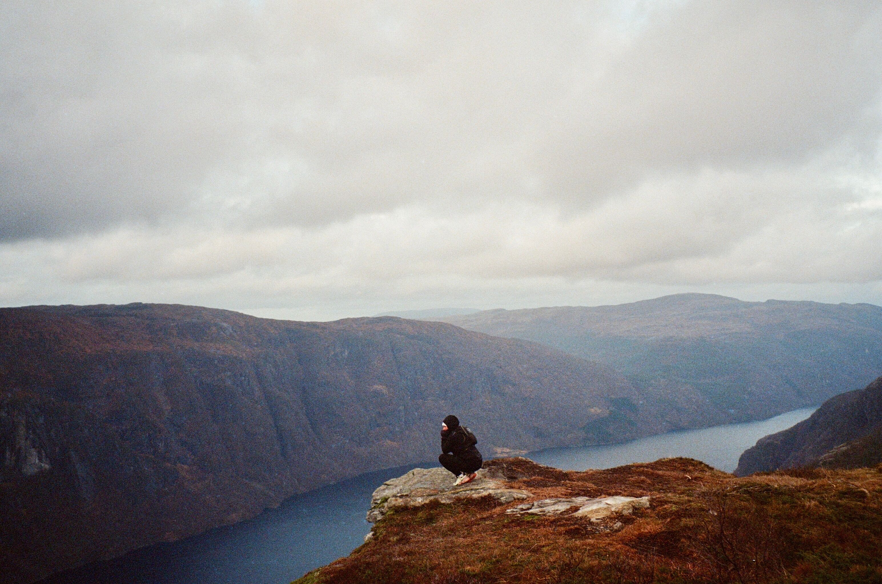 Hiker Gazes Over Stunning Norwegian Fjord · Free Stock Photo