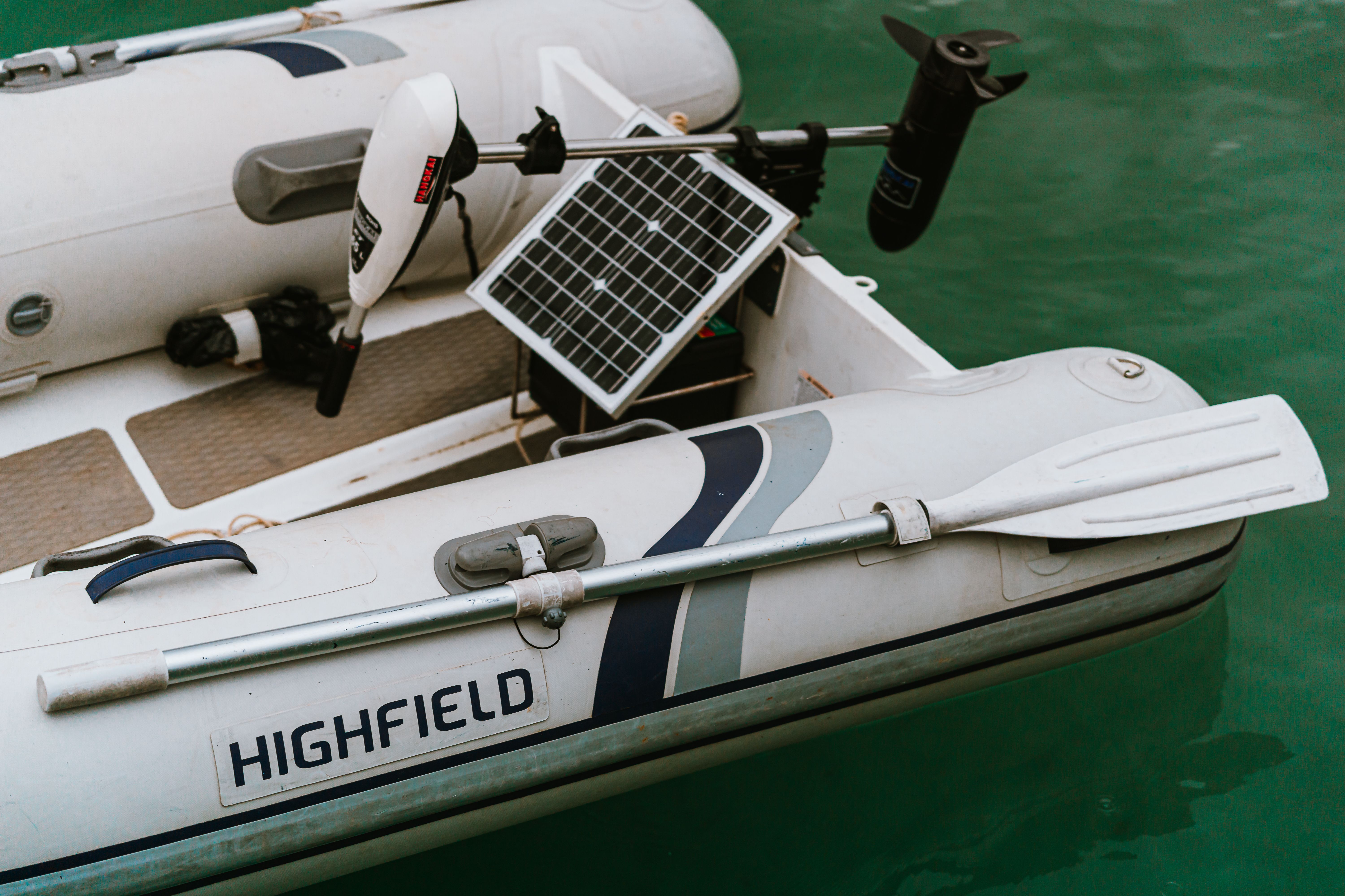 Inflatable Boat with Solar Panel on Calm Water · Free Stock Photo