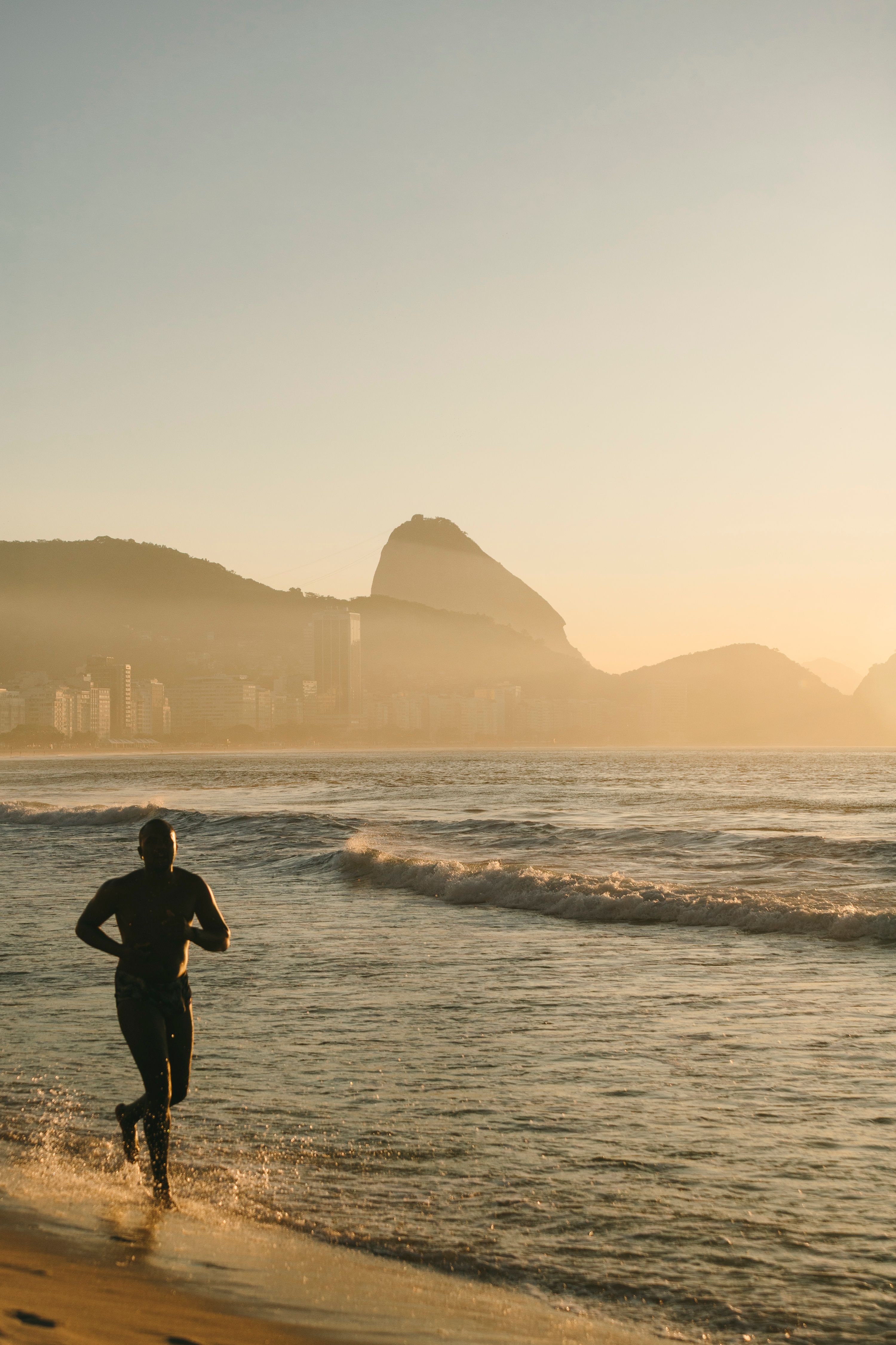 Runner on Copacabana Beach during Sunrise in Rio · Free Stock Photo