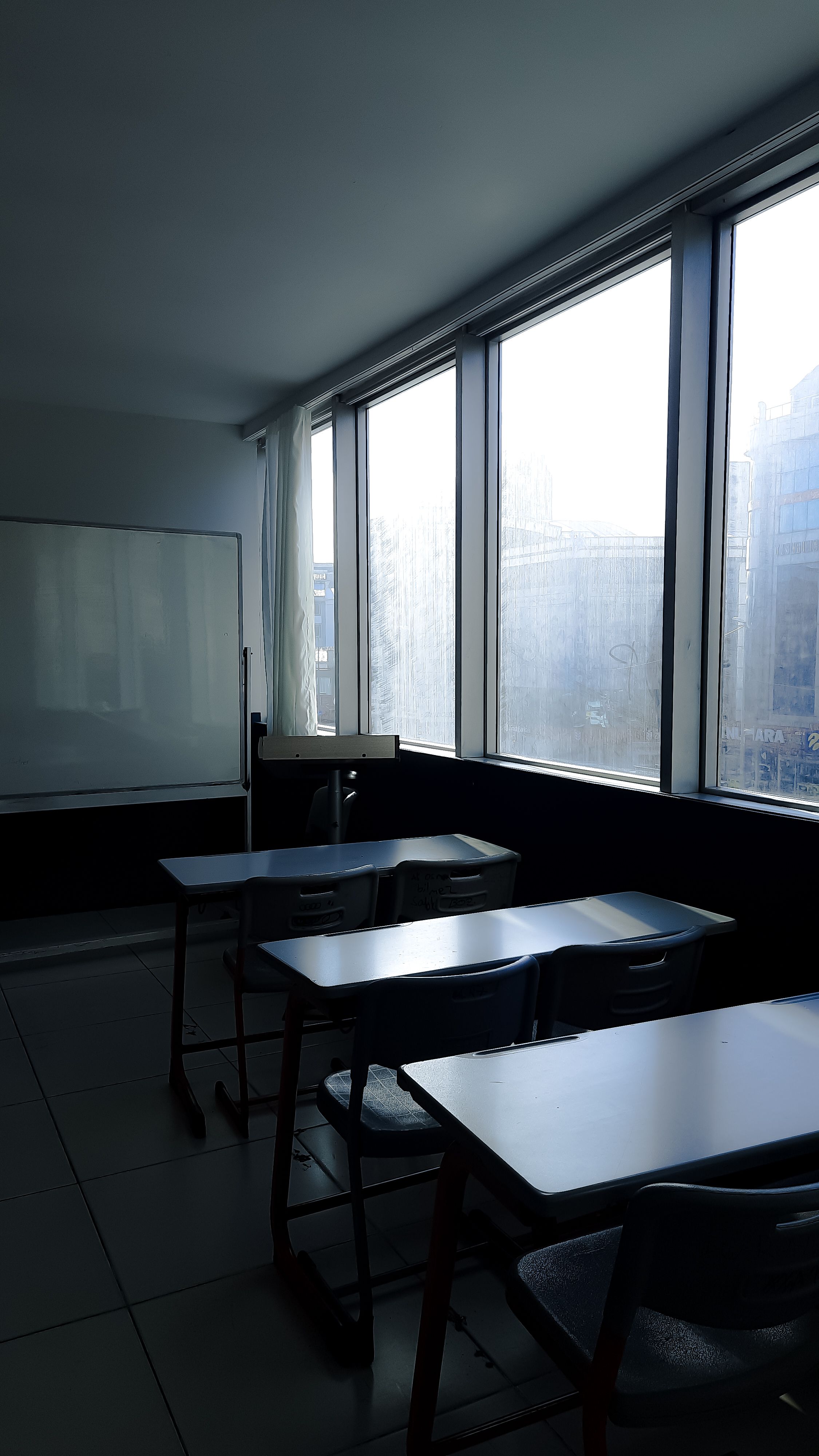 Empty Classroom with Large Windows and Desks · Free Stock Photo