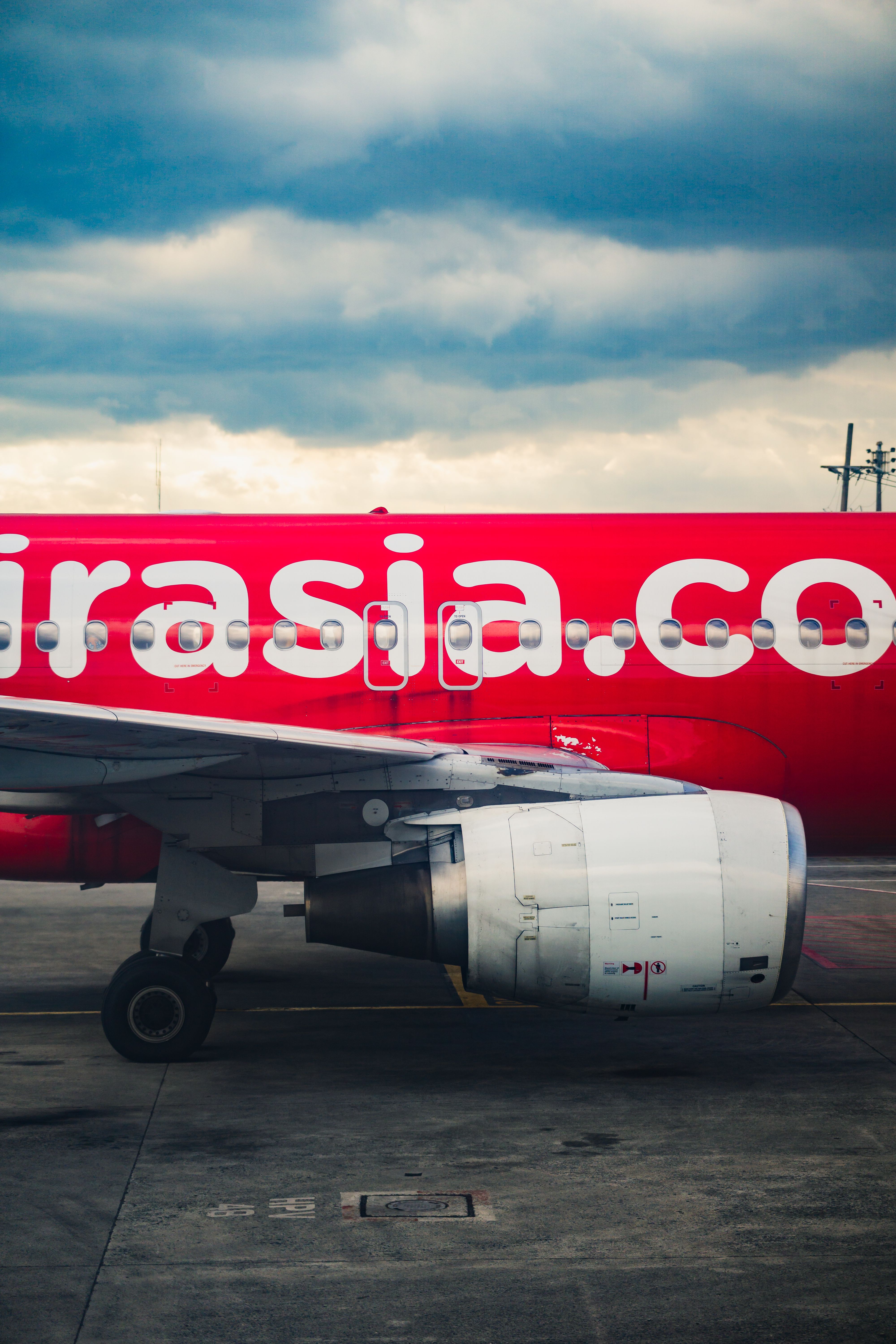 Side view of red aircraft on runway · Free Stock Photo