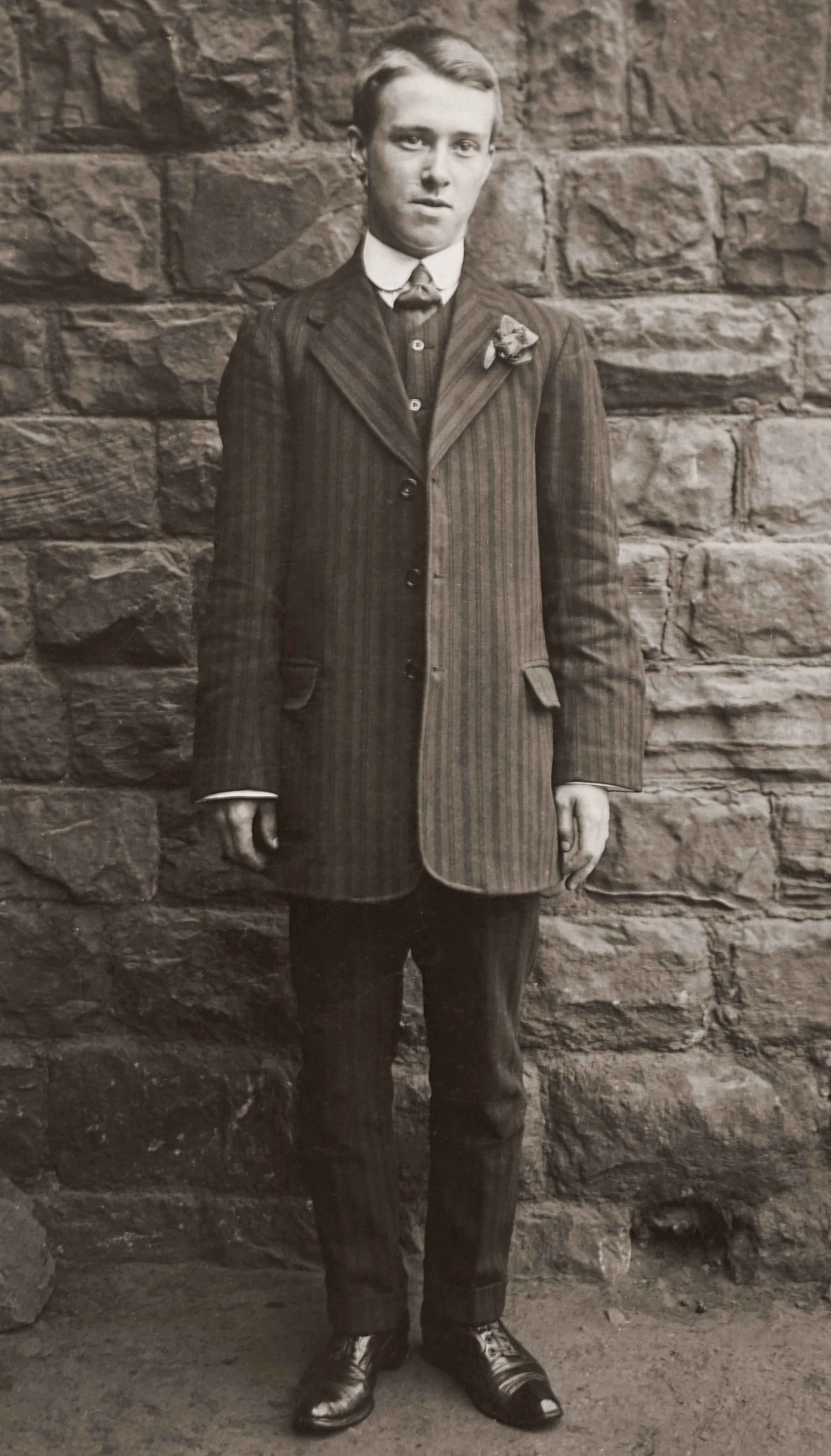 Grayscale Photo of Man in Gray Suit Standing Near A Stone Wall · Free ...