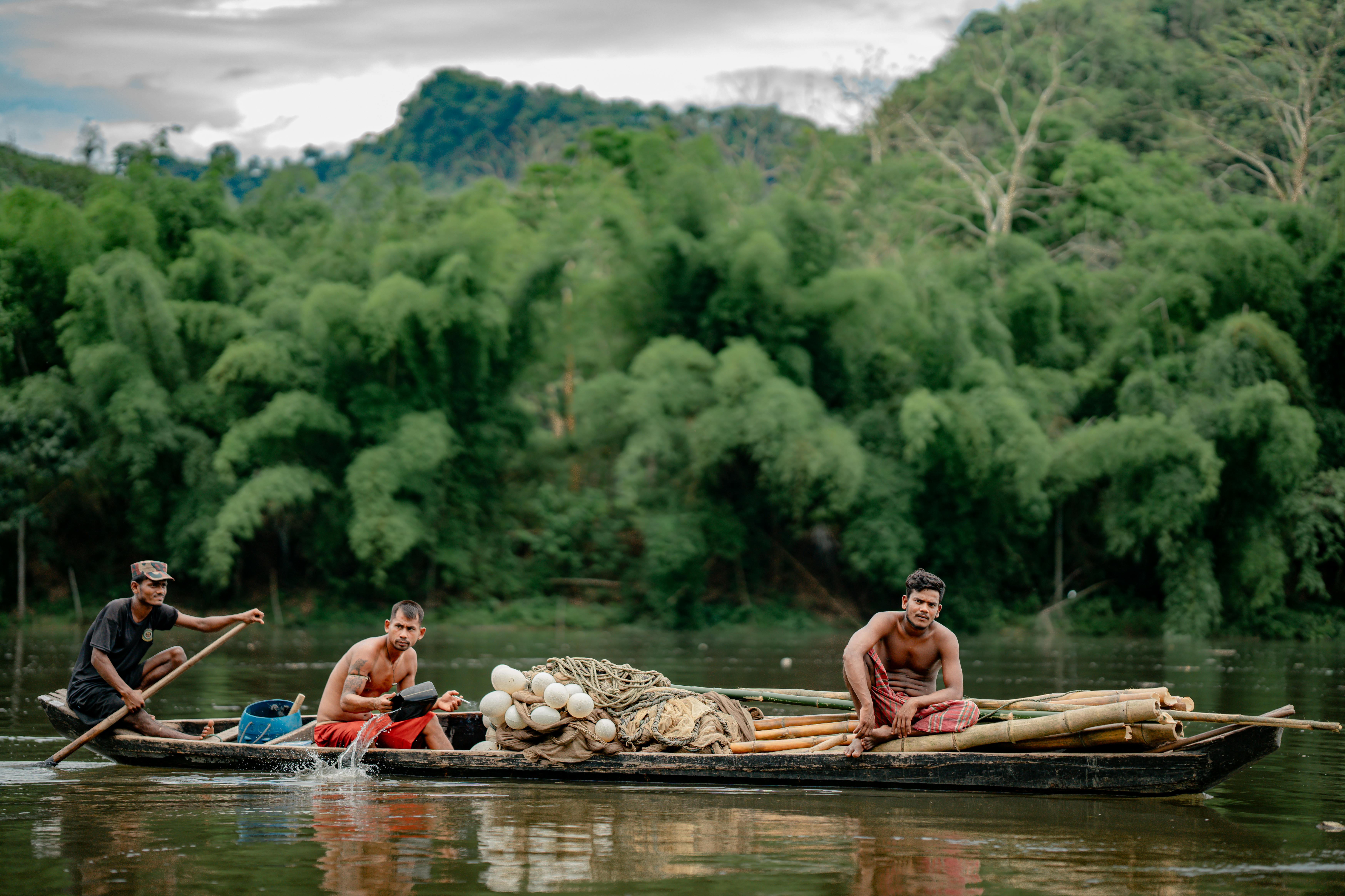 Traditional Fishing in Lush Green River Landscape · Free Stock Photo