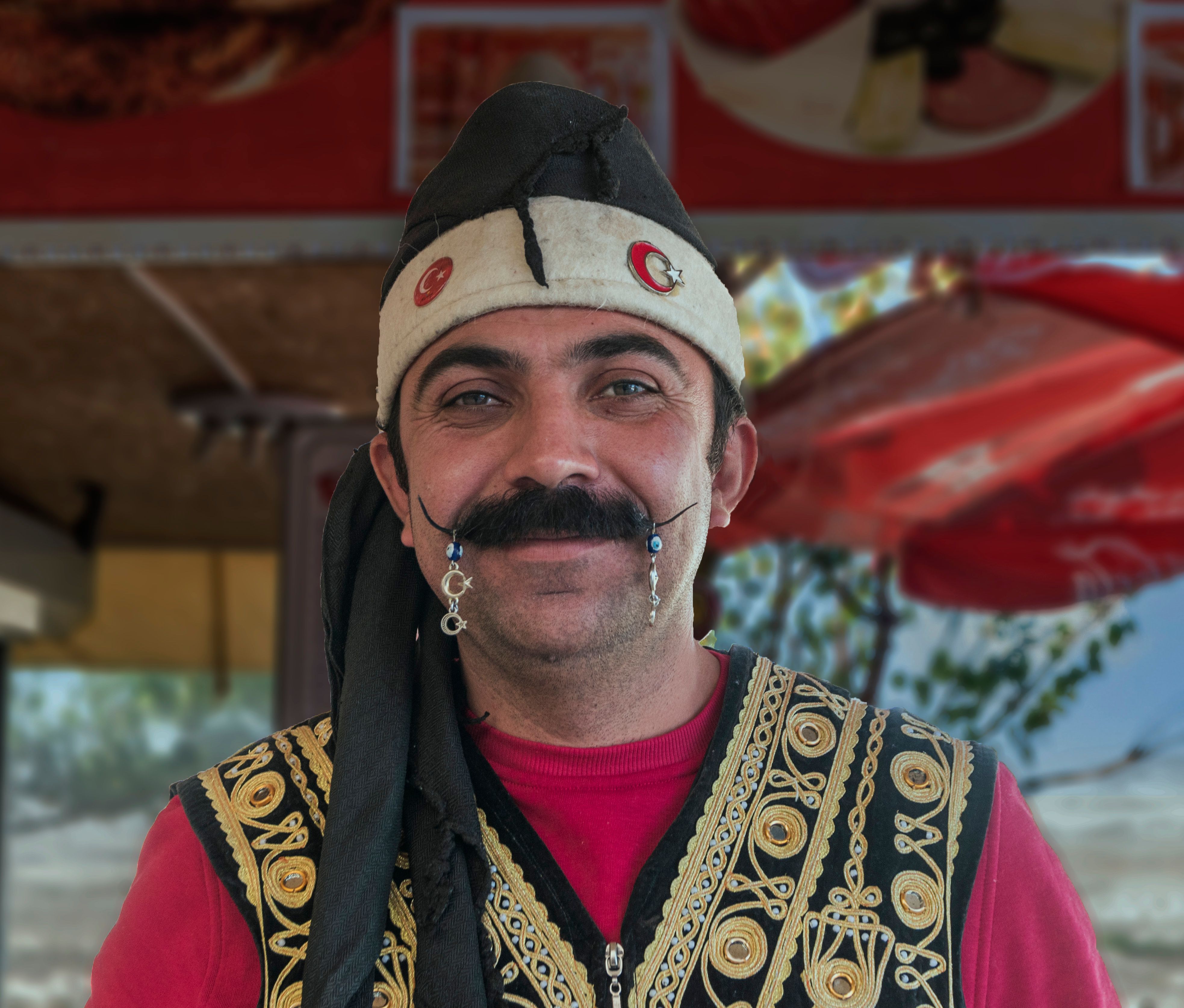 Smiling Turkish Ice Cream Vendor in Traditional Attire · Free Stock Photo
