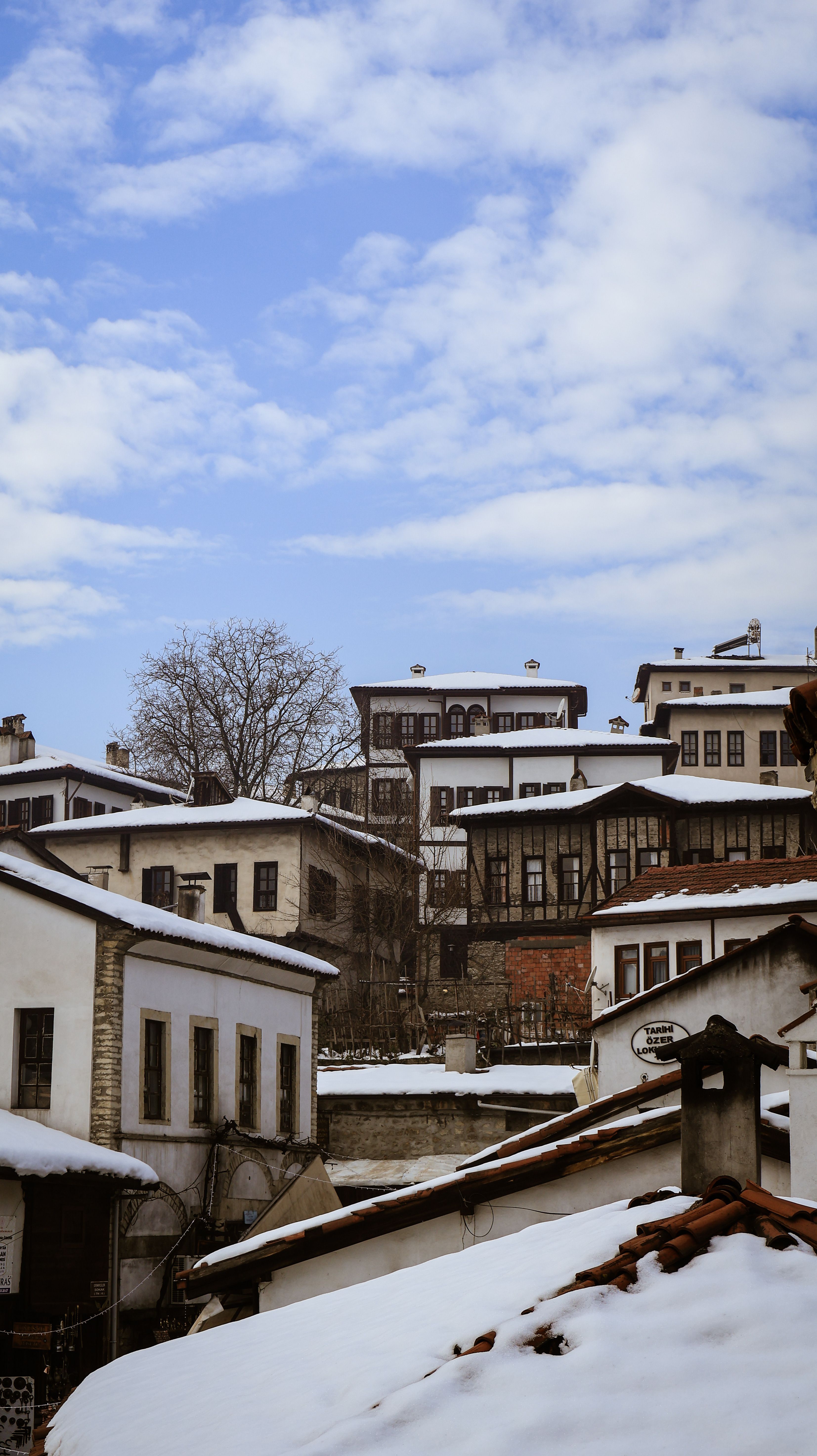 Snow-Covered Traditional Buildings Under Blue Sky · Free Stock Photo