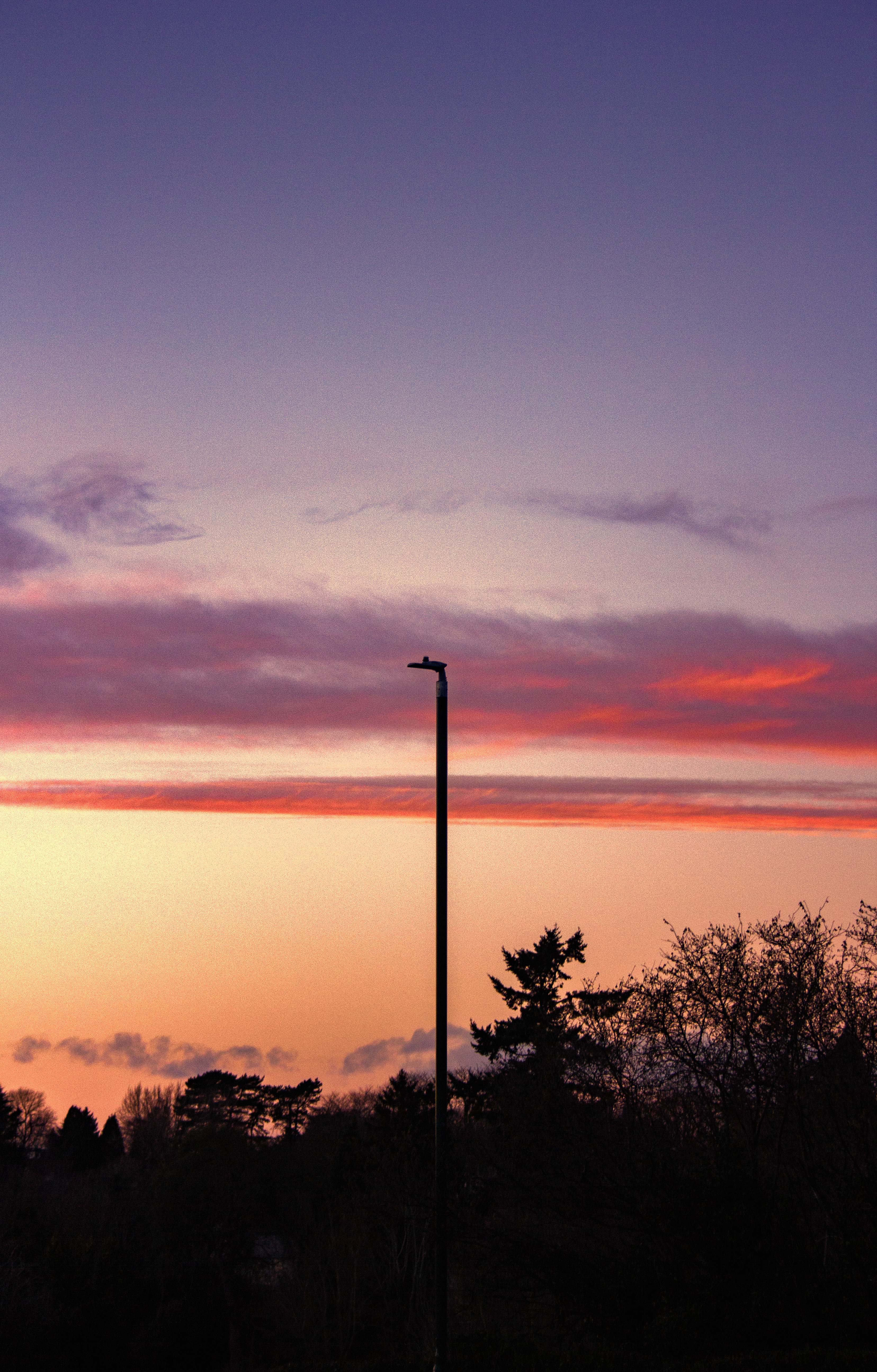 Silhouette of a Lamp Post Against Vibrant Sunset · Free Stock Photo