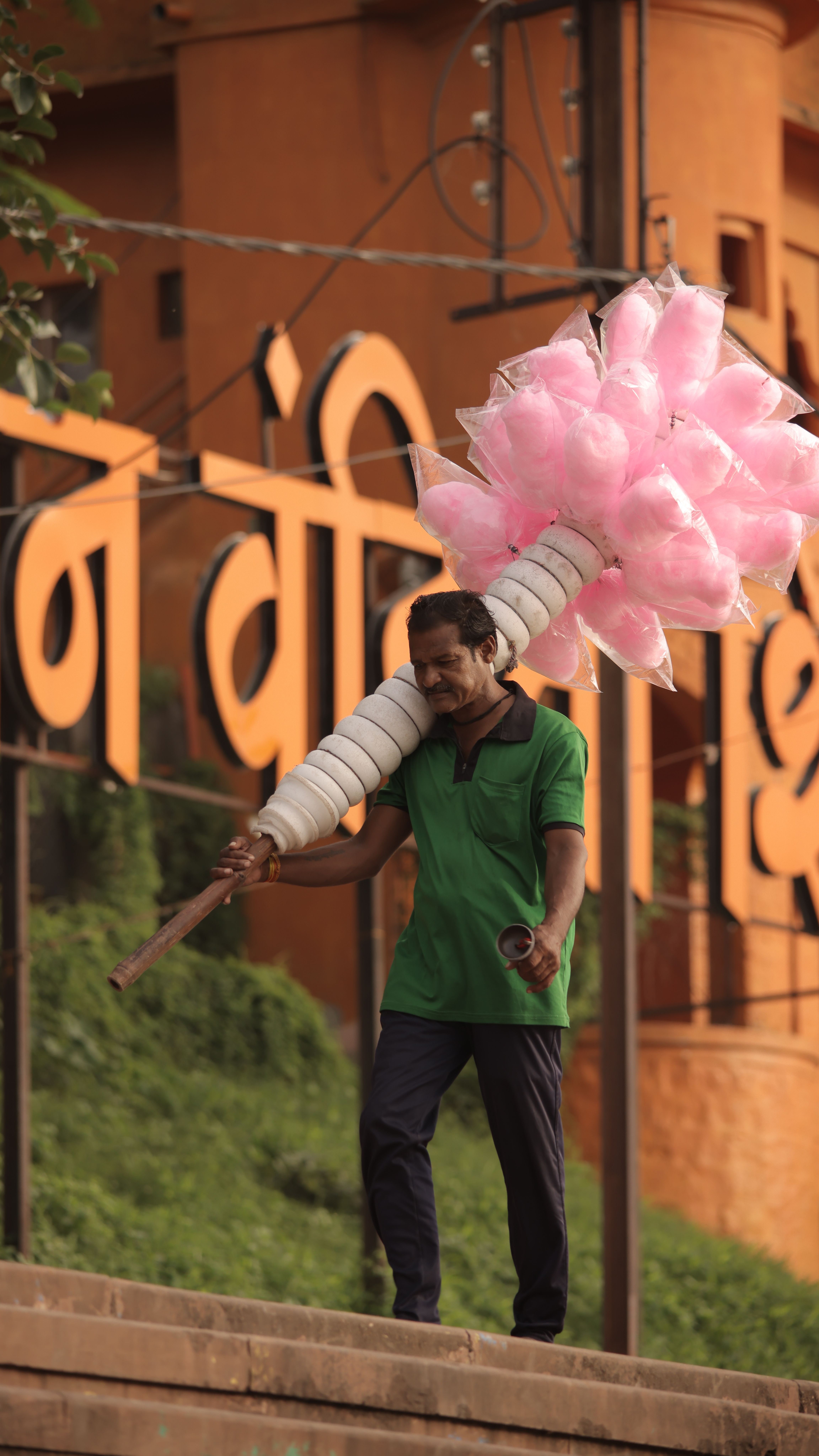 Vendor Carrying Cotton Candy on City Street · Free Stock Photo