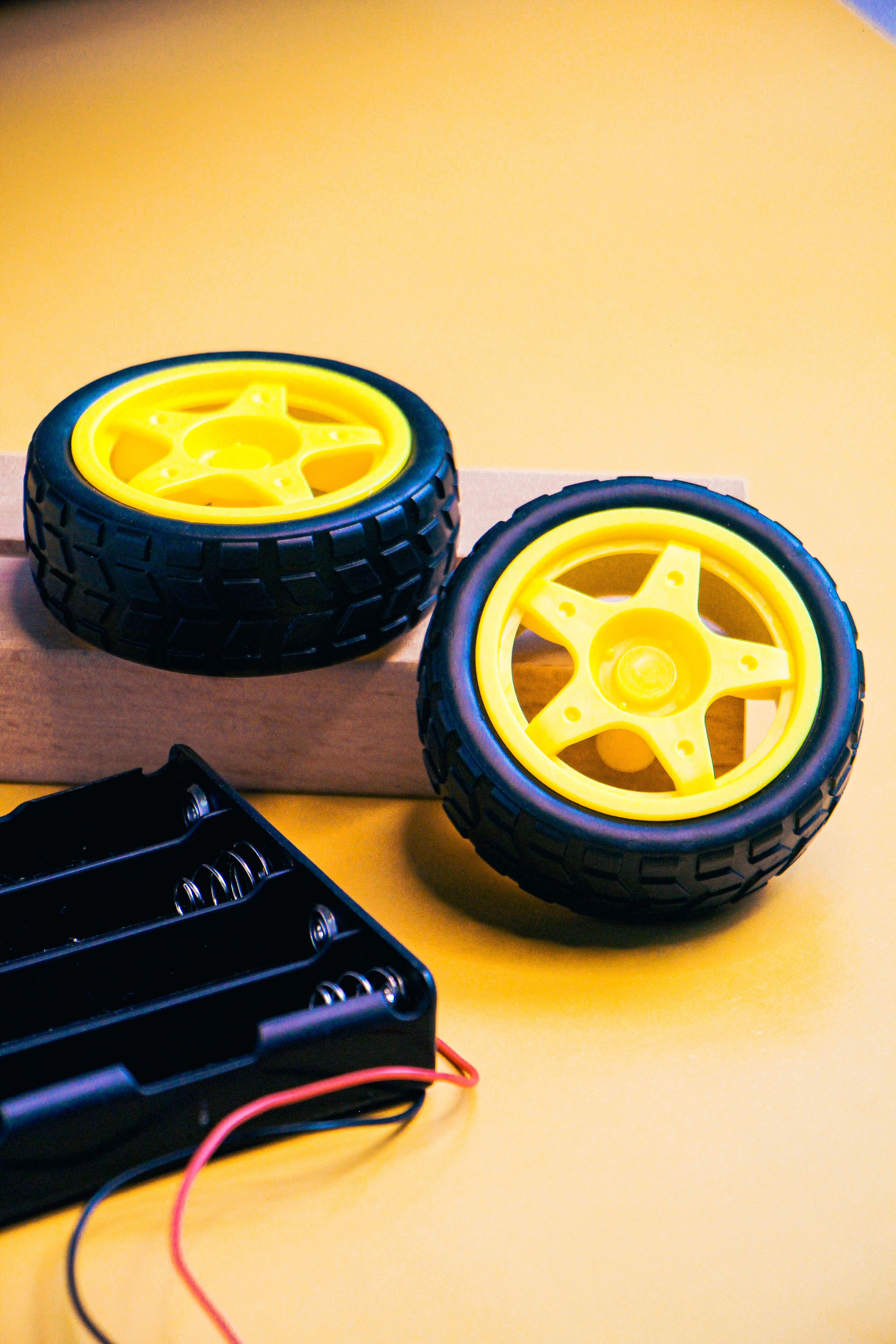 Robotics Kit with Yellow Wheels on Yellow Background · Free Stock Photo