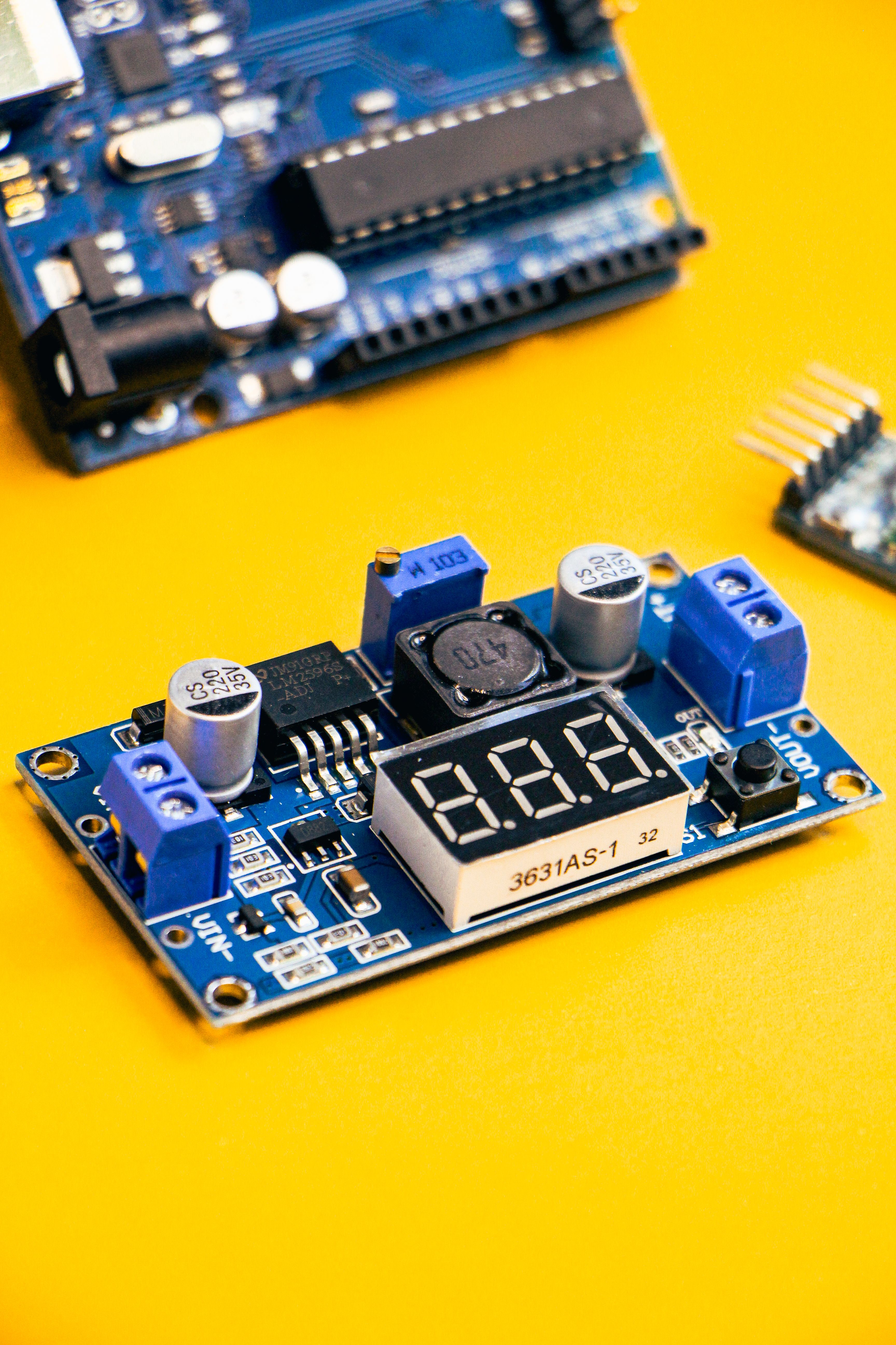 Electronic Circuit Board on Vibrant Yellow Background · Free Stock Photo
