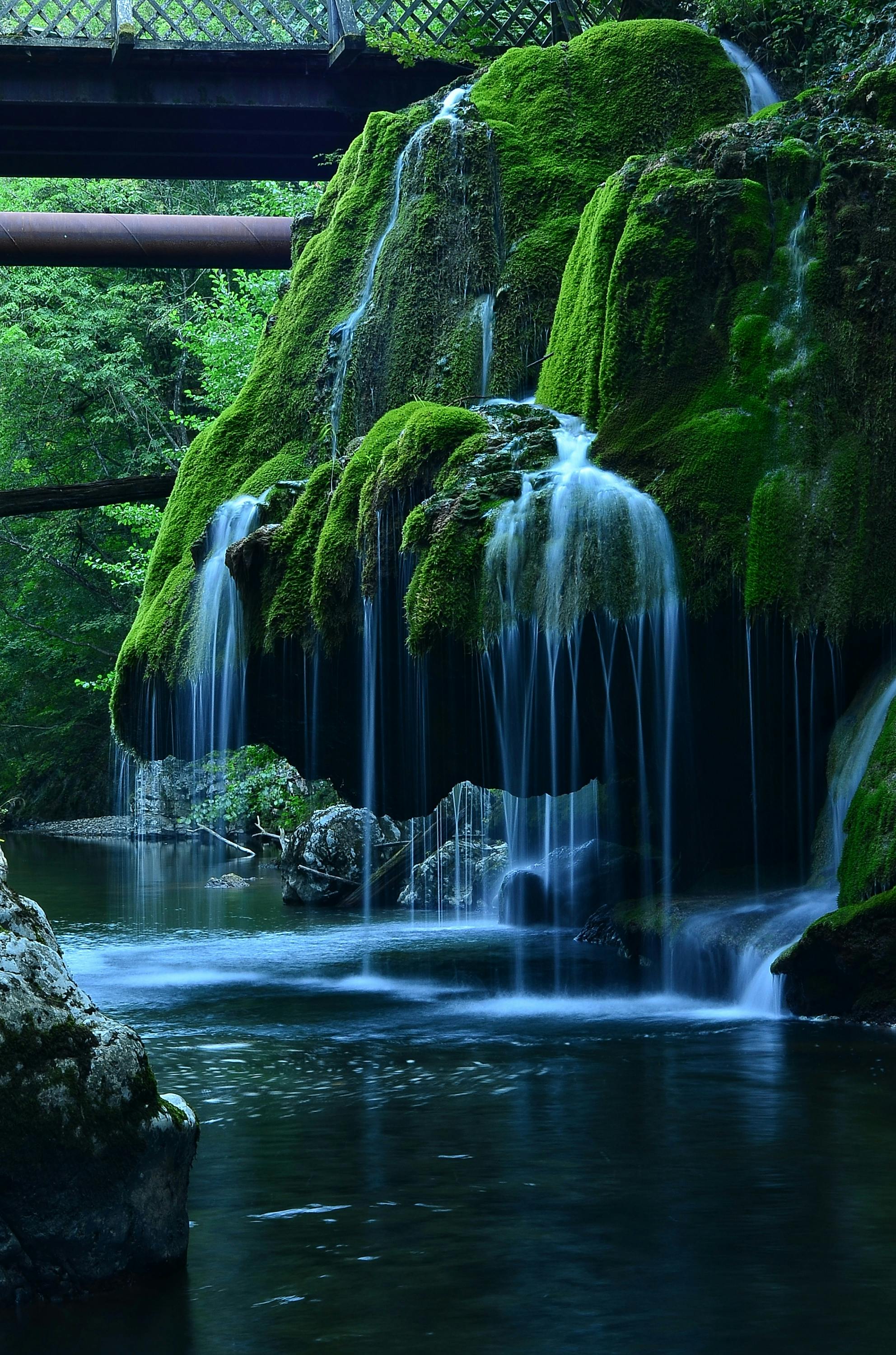 Time-Lapse Photo of Waterfalls in Mossy Rock Formation · Free Stock Photo