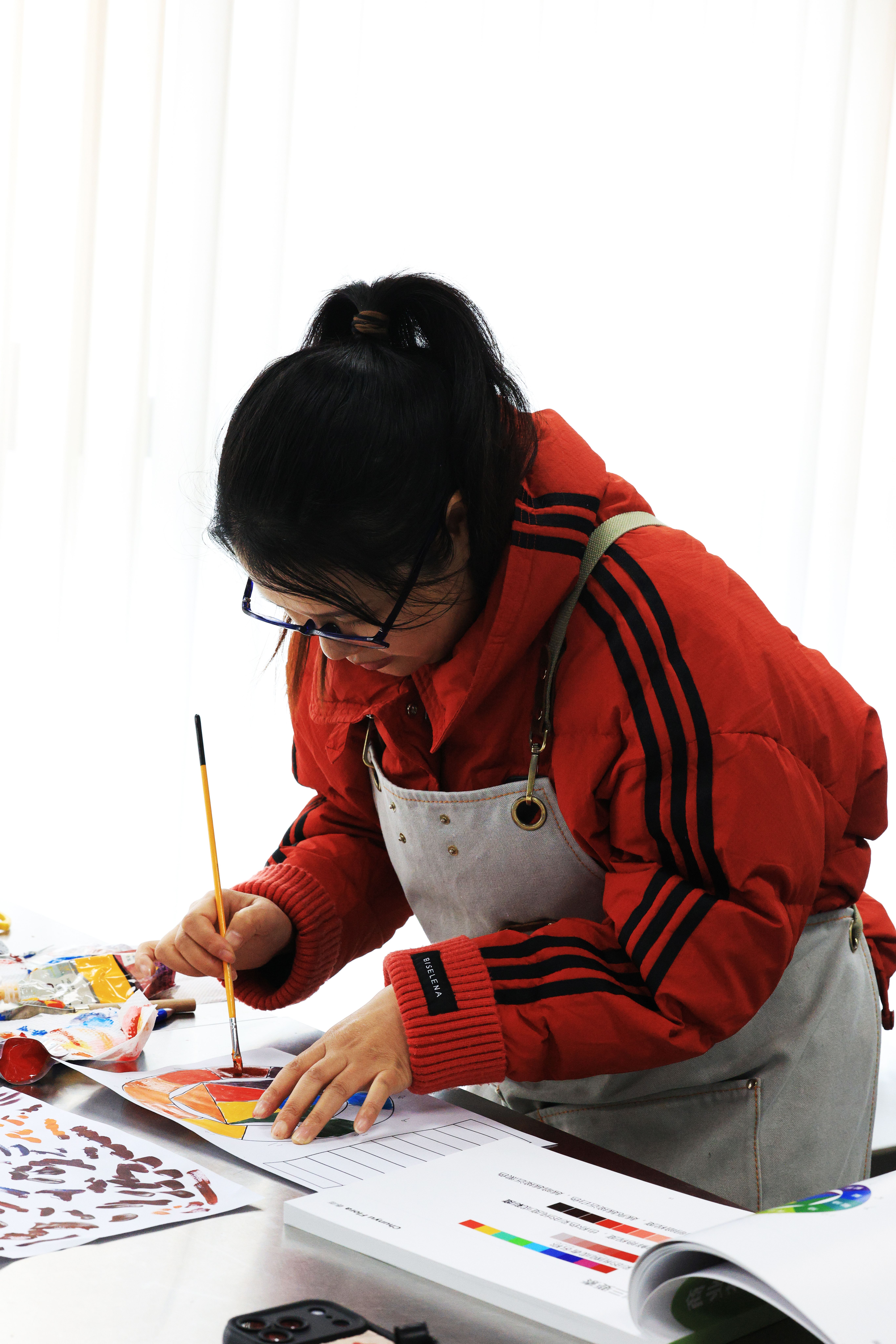 Focused Artist Creating Vibrant Artwork · Free Stock Photo