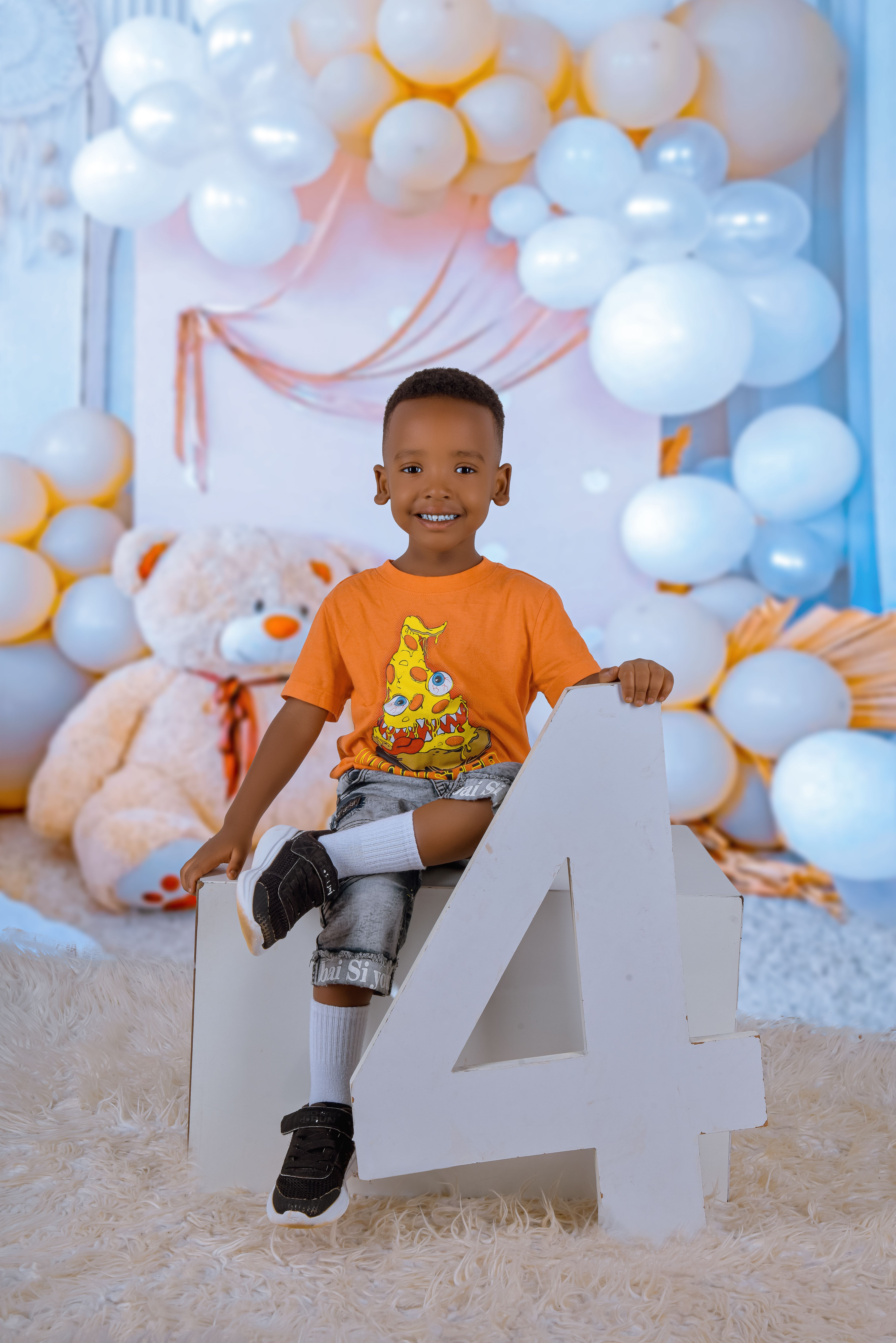 Child Celebrating Fourth Birthday with Balloons · Free Stock Photo