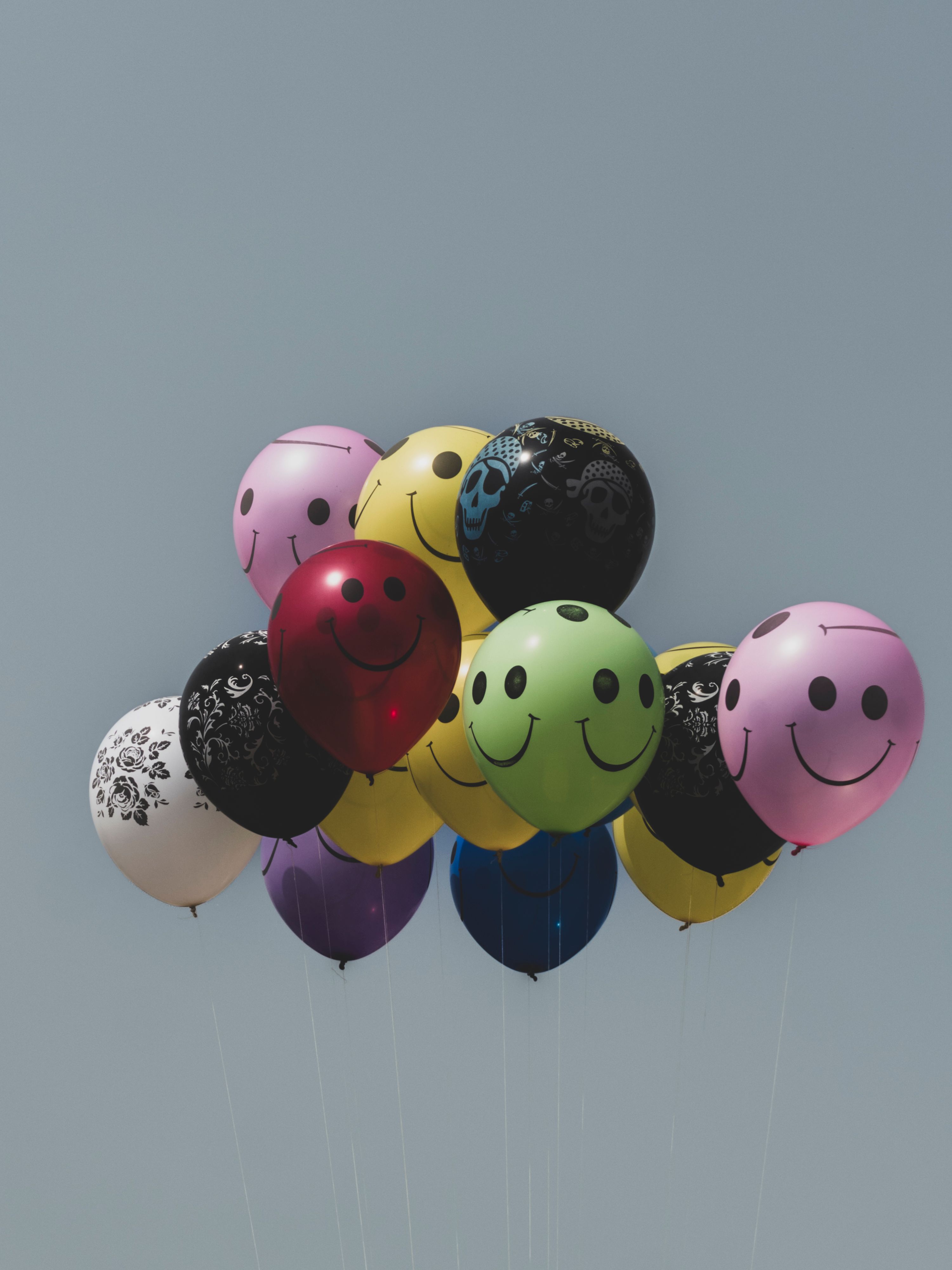 Colorful Smiley Balloons against Blue Sky · Free Stock Photo