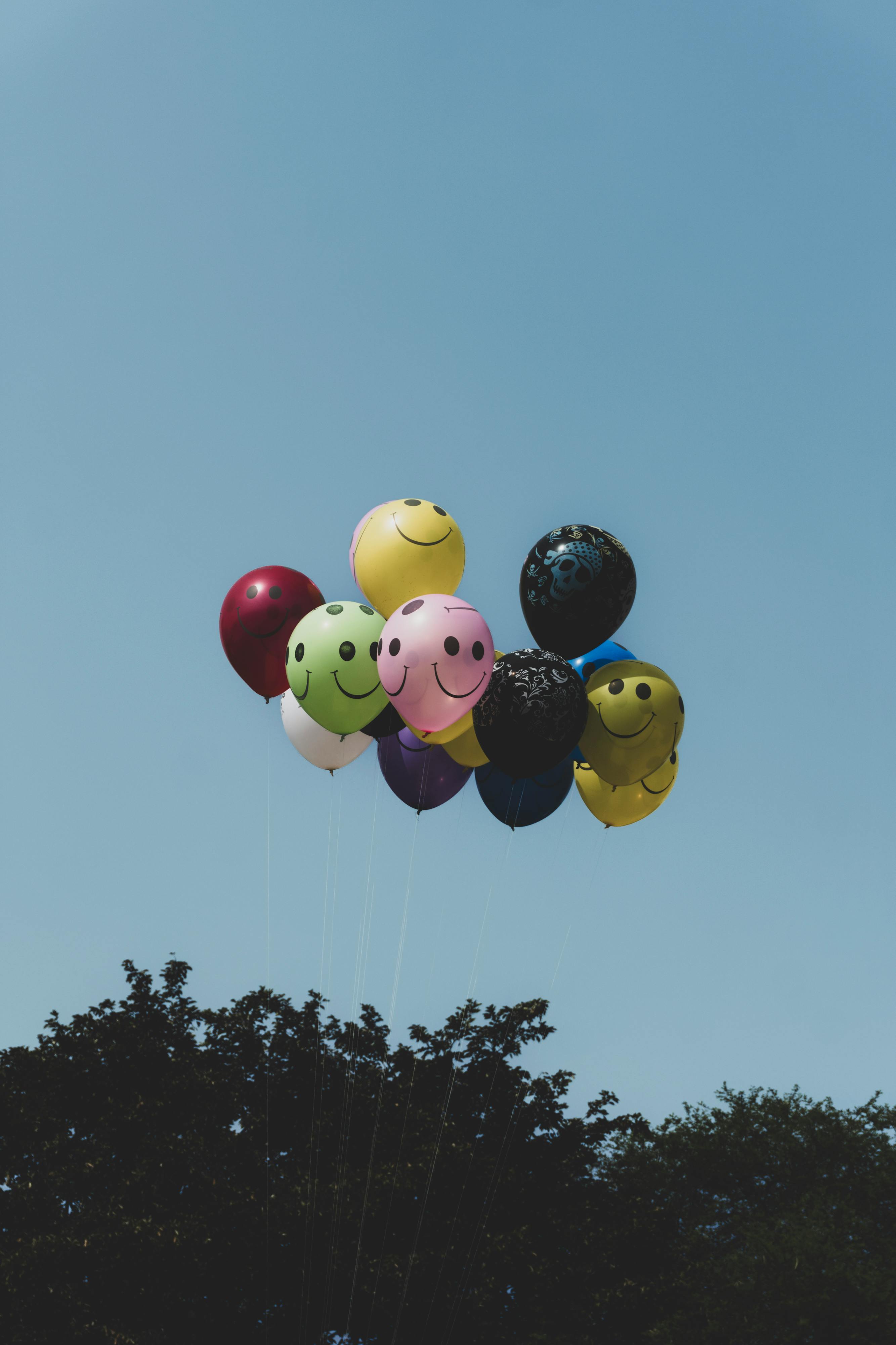 Colorful Smile Balloons Floating in Clear Sky · Free Stock Photo