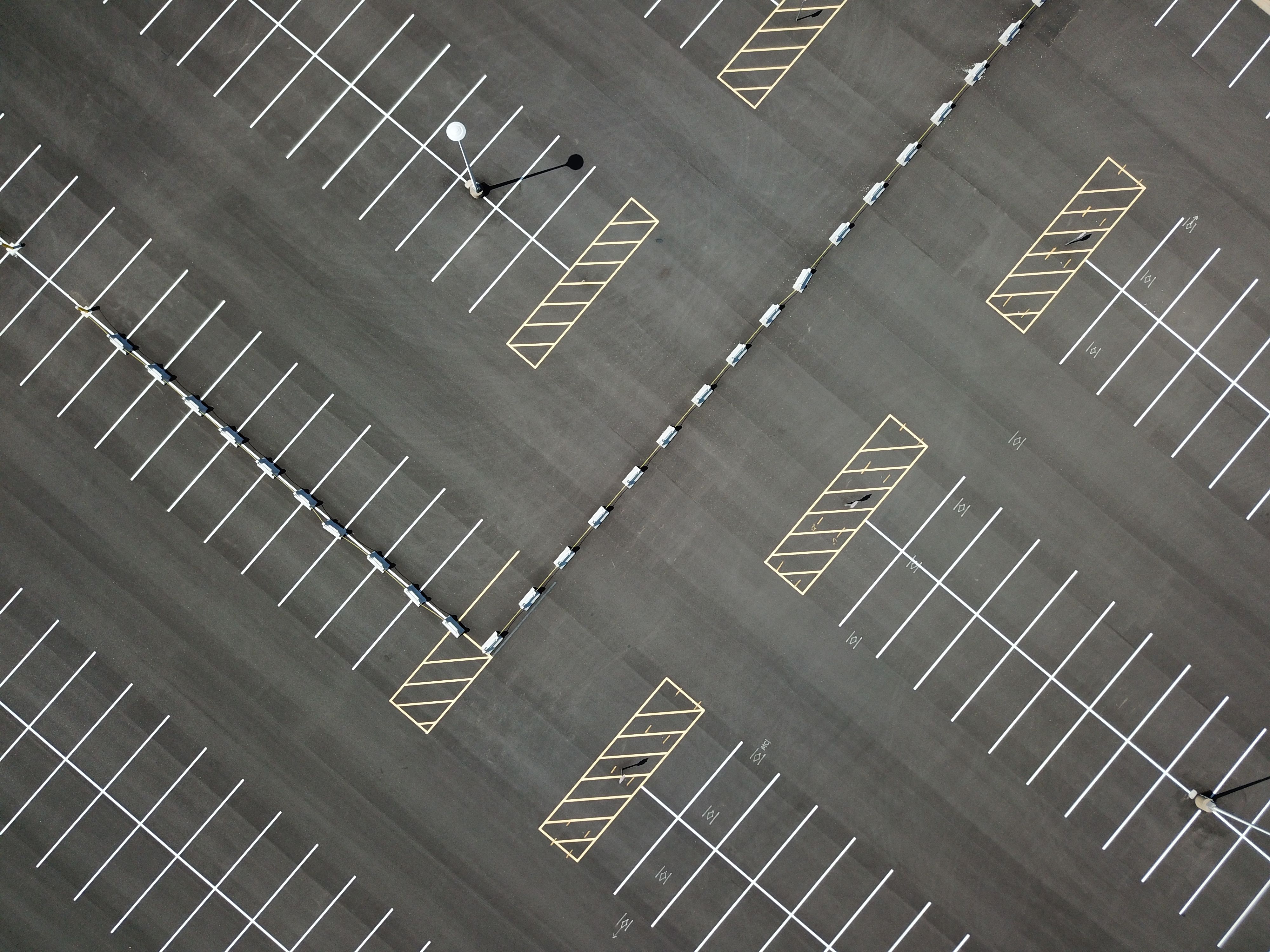 Aerial View of Empty Parking Lot with Markings · Free Stock Photo
