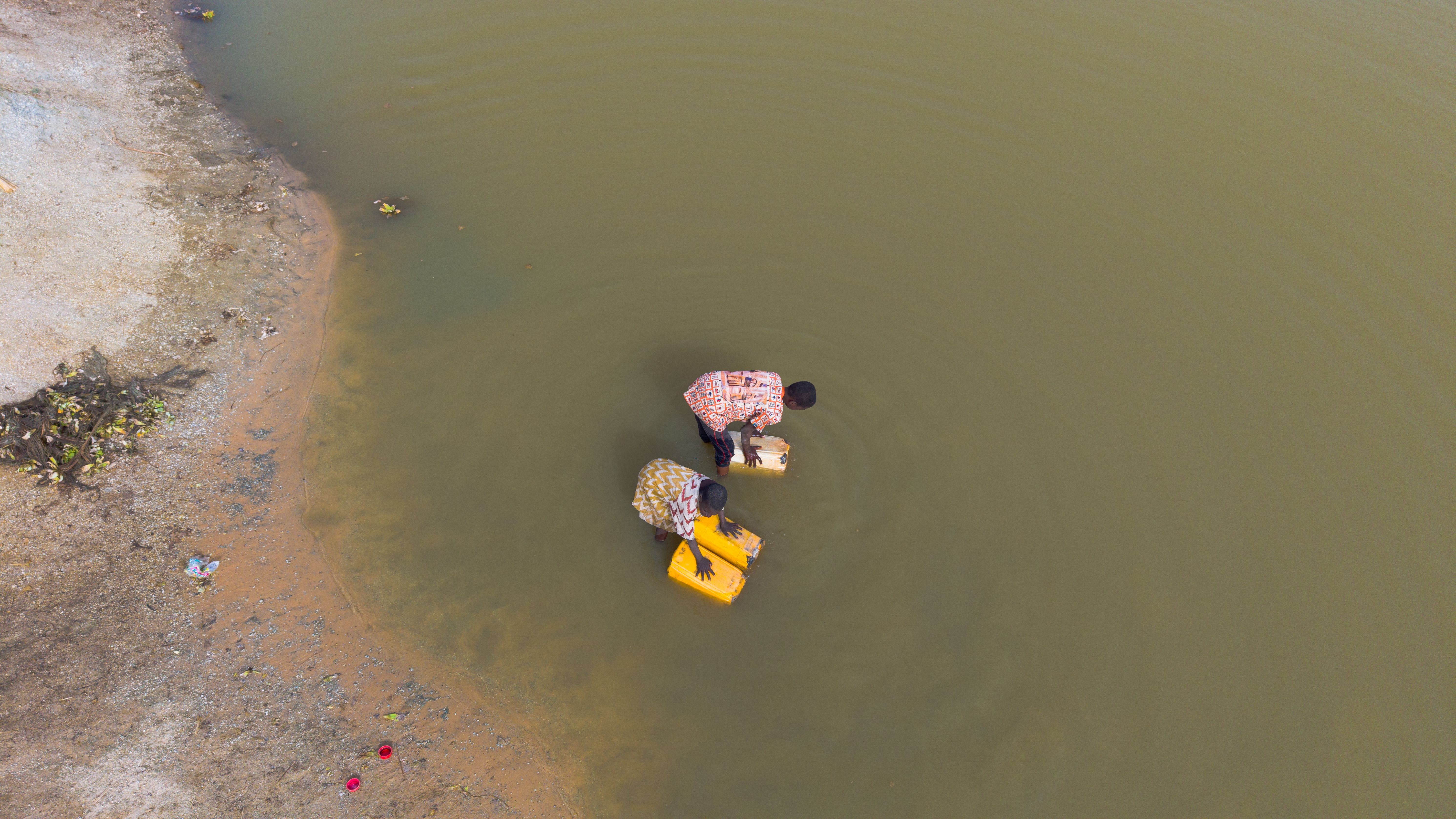 Aerial View of People Collecting Water in River · Free Stock Photo