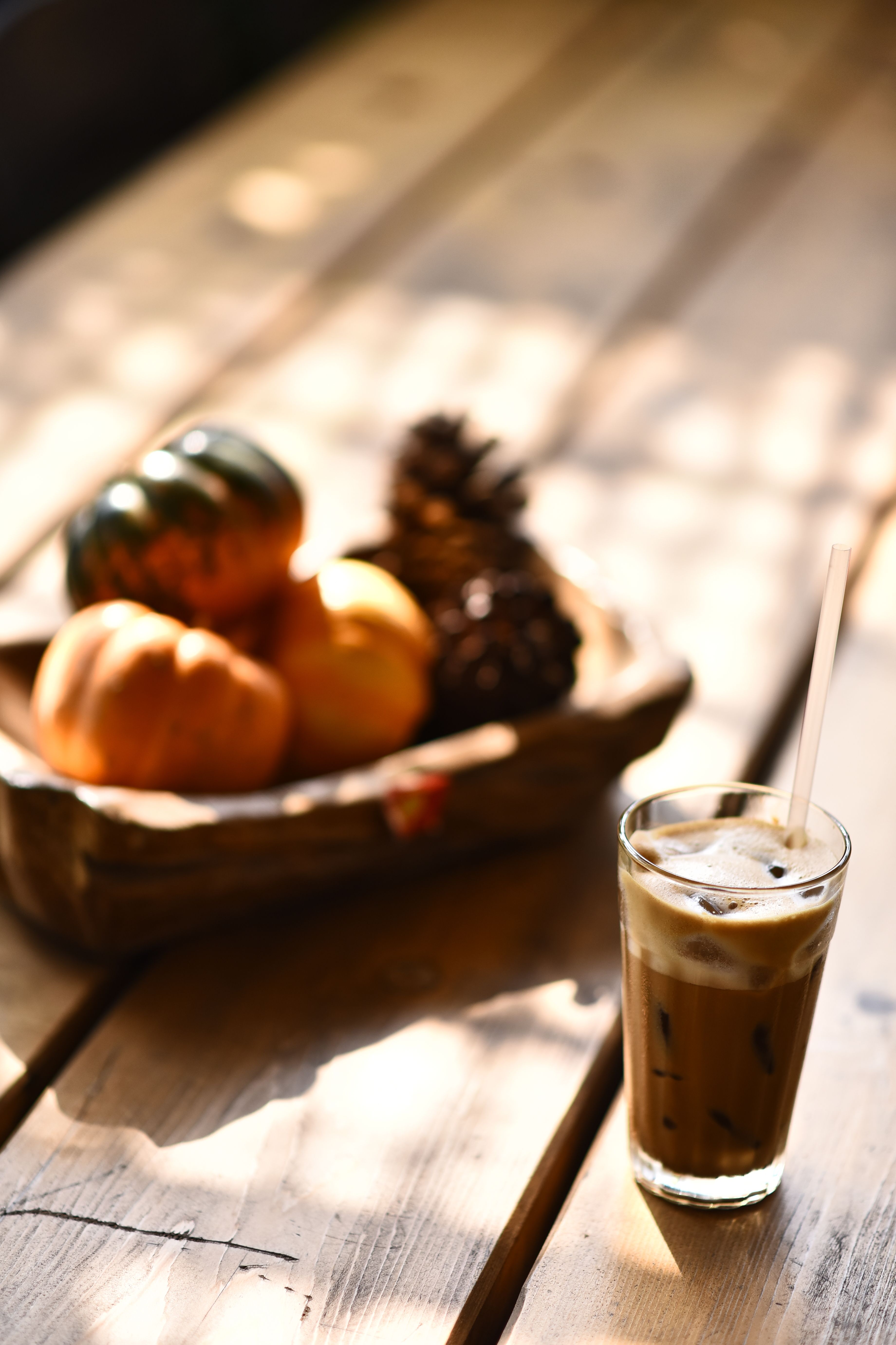 Autumn Iced Coffee with Harvest Decor on a Sunny Table · Free Stock Photo