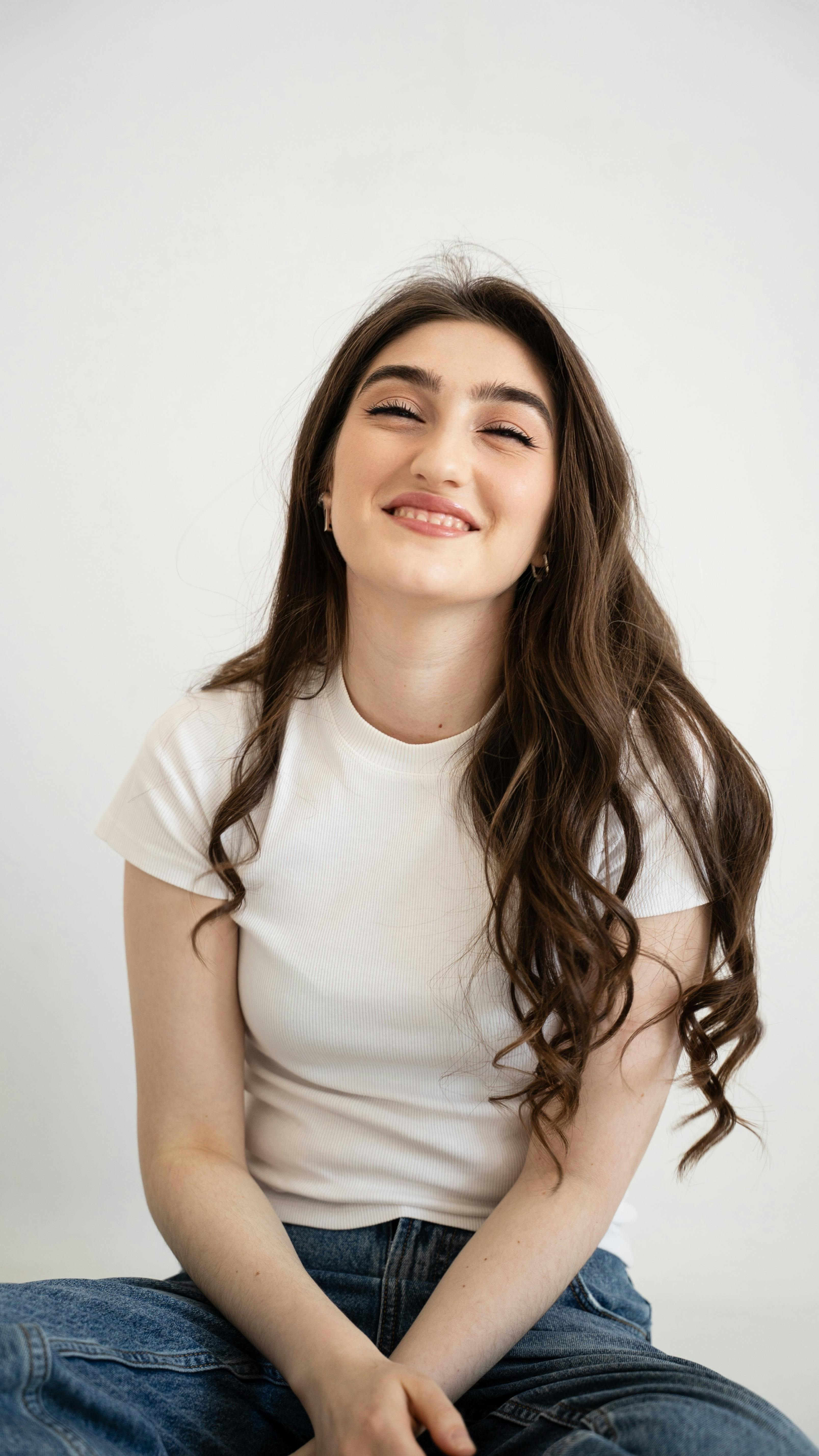 Joyful Young Woman Smiling Indoors · Free Stock Photo