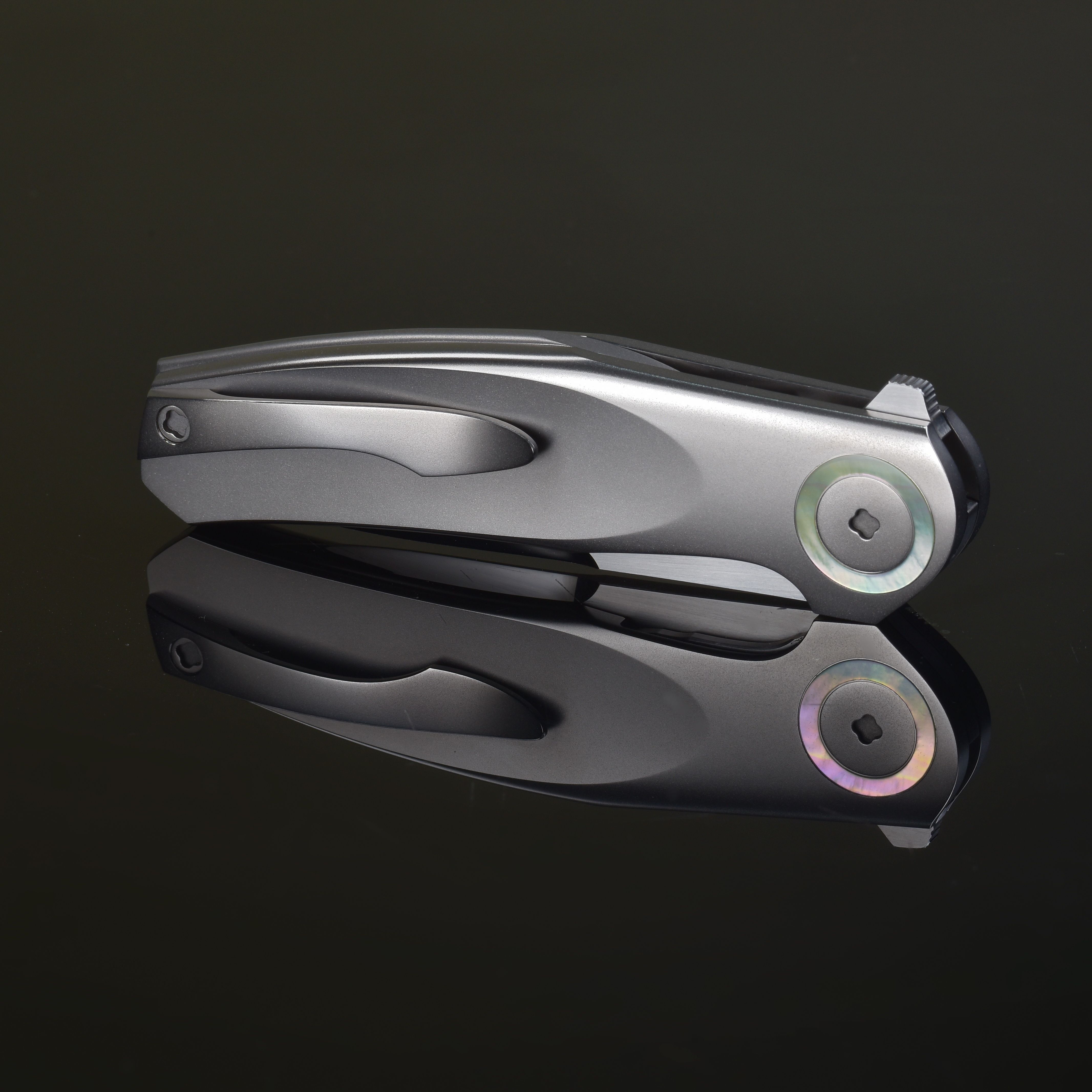 Sleek Stainless Steel Folding Pocket Knife Reflection · Free Stock Photo