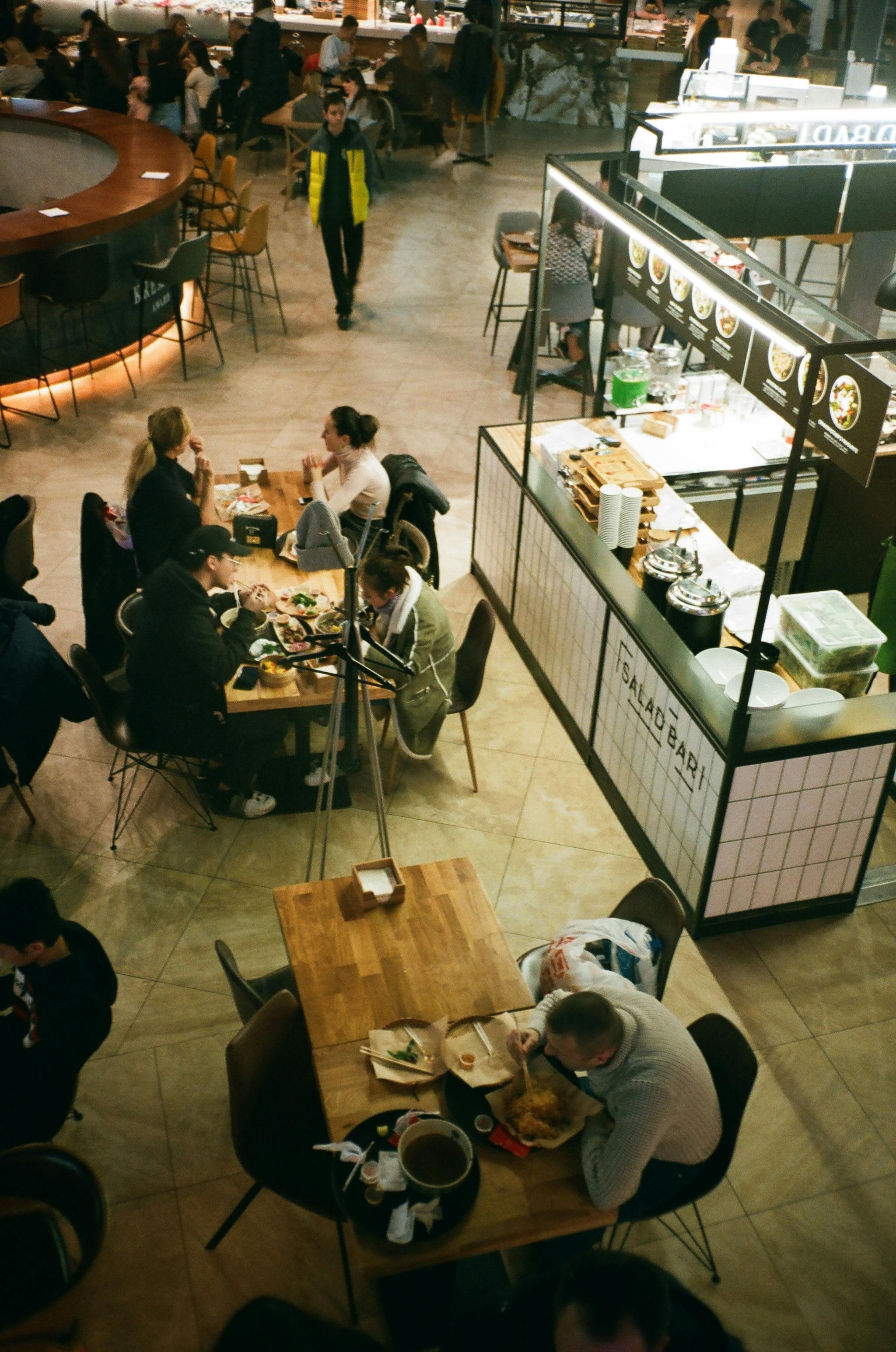 People Eating in Front of Food Stalls · Free Stock Photo