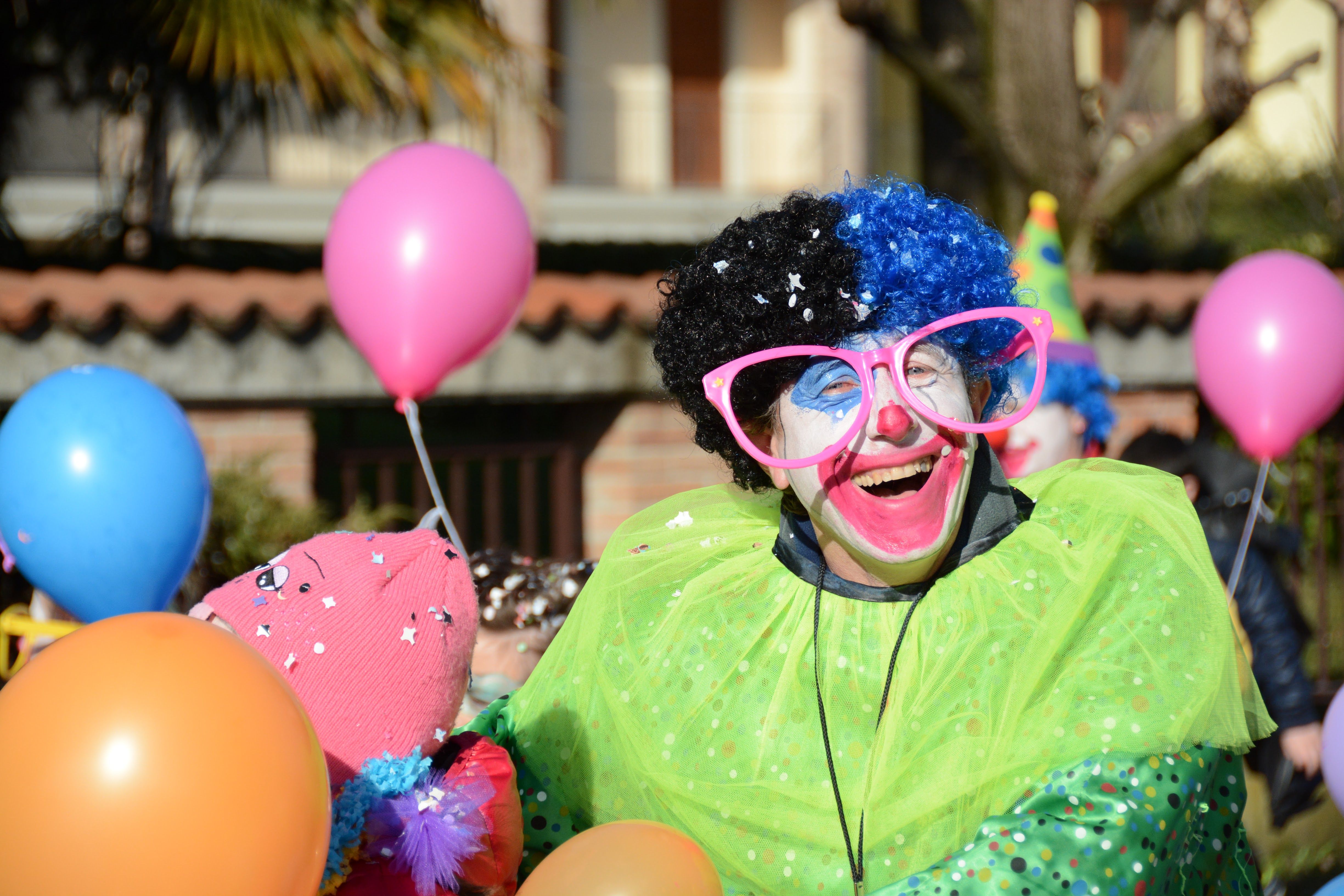Colorful Clown Celebrating at Outdoor Carnival · Free Stock Photo