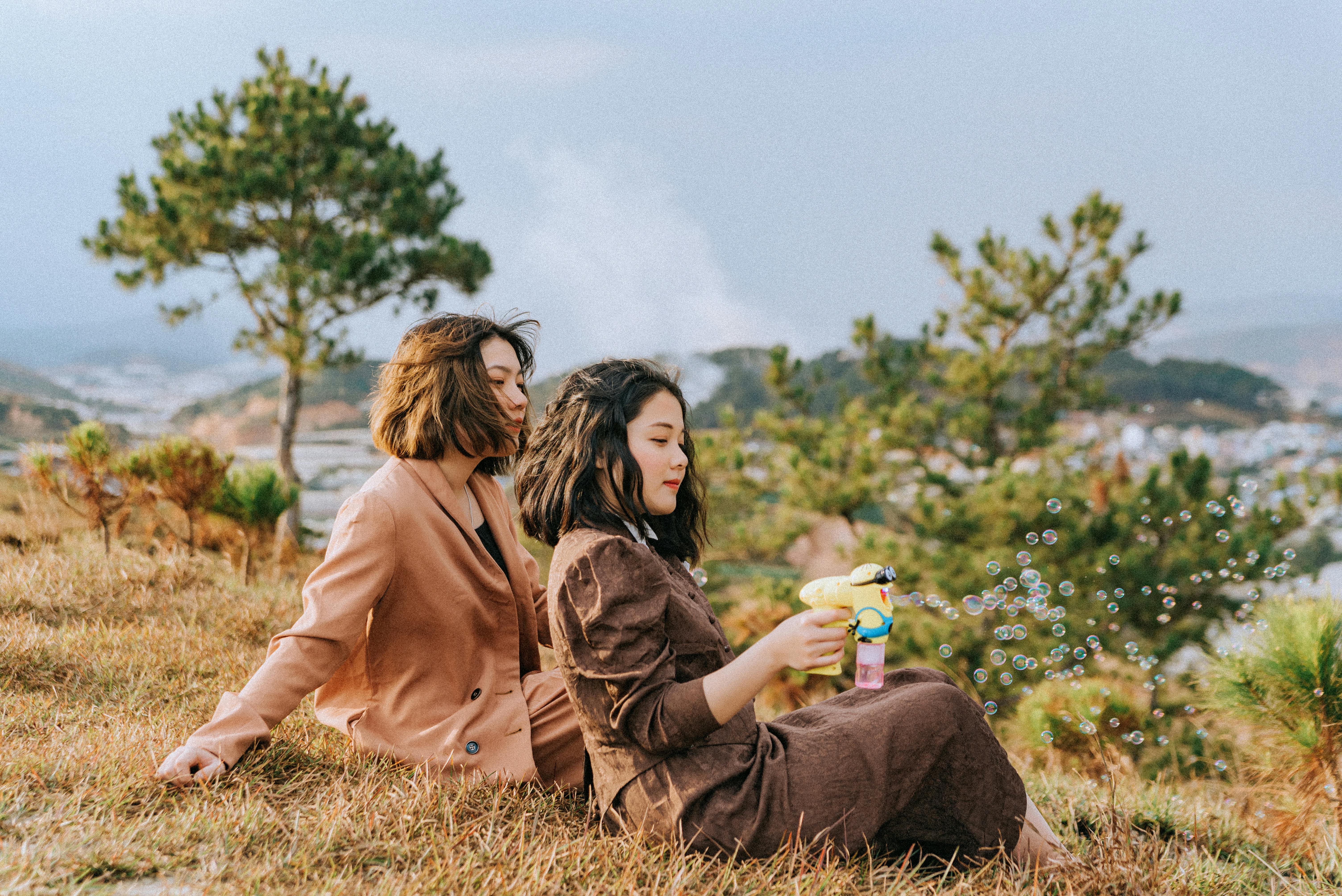 Two Women Sitting on Ground · Free Stock Photo