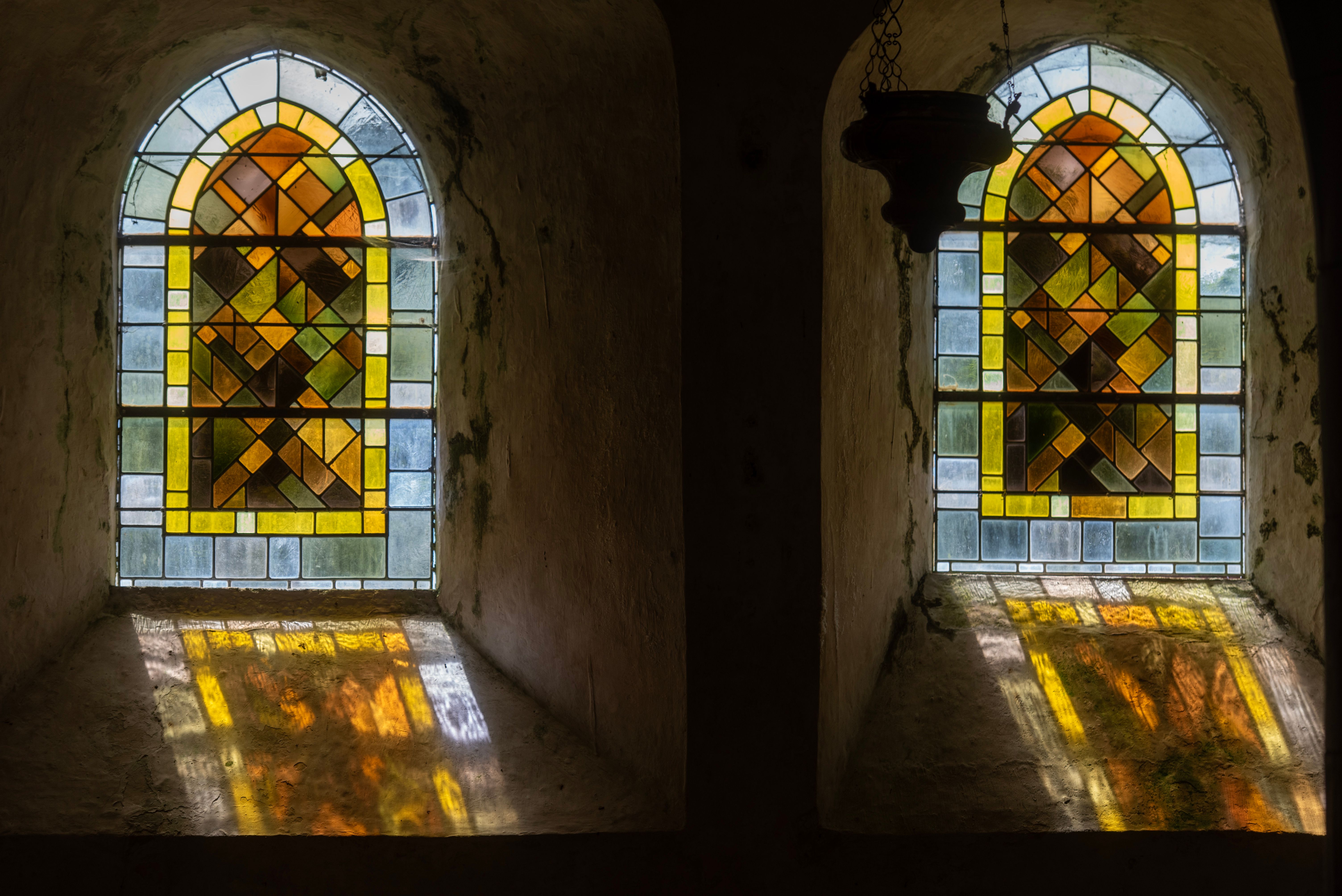 Stained Glass Windows Casting Vibrant Patterns · Free Stock Photo