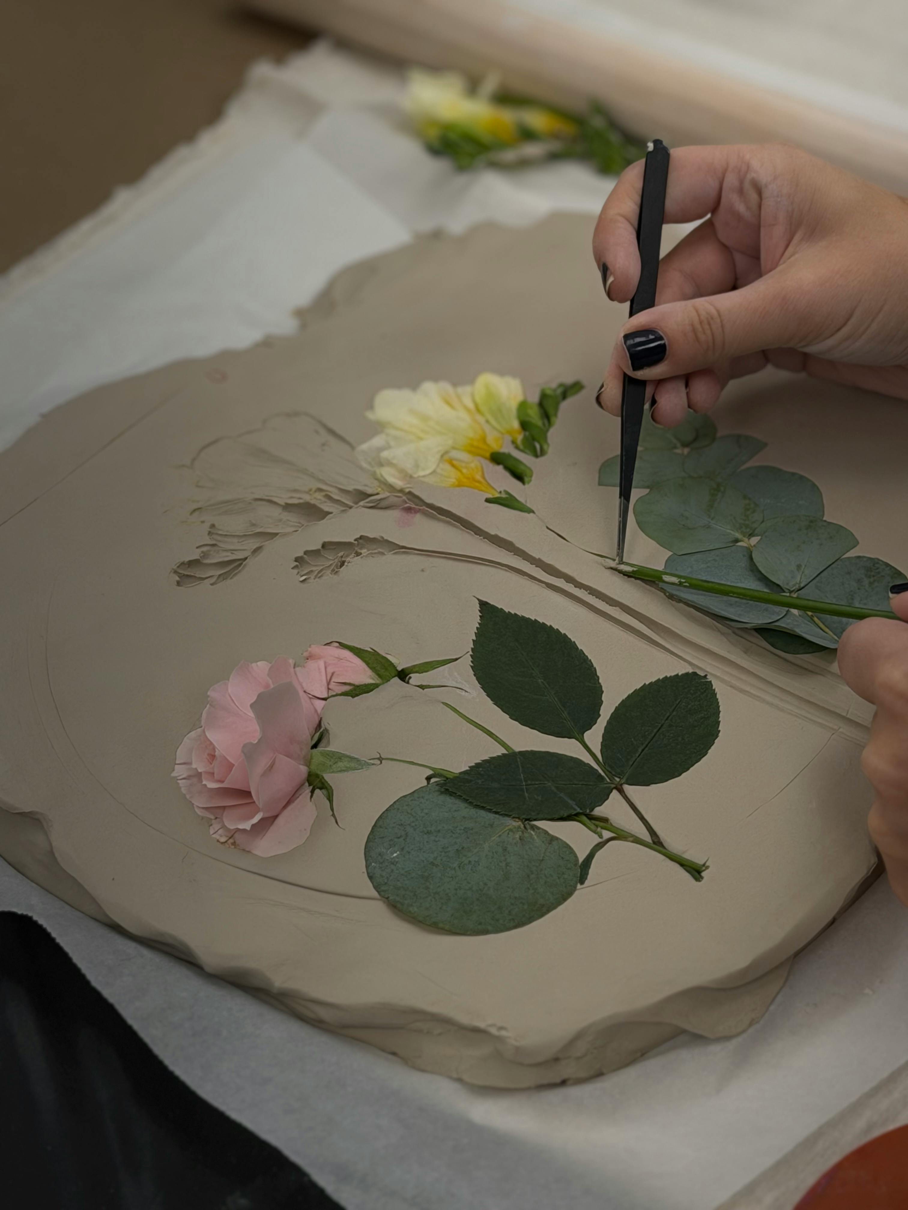 Creative Floral Pattern Pressing on Clay Surface · Free Stock Photo