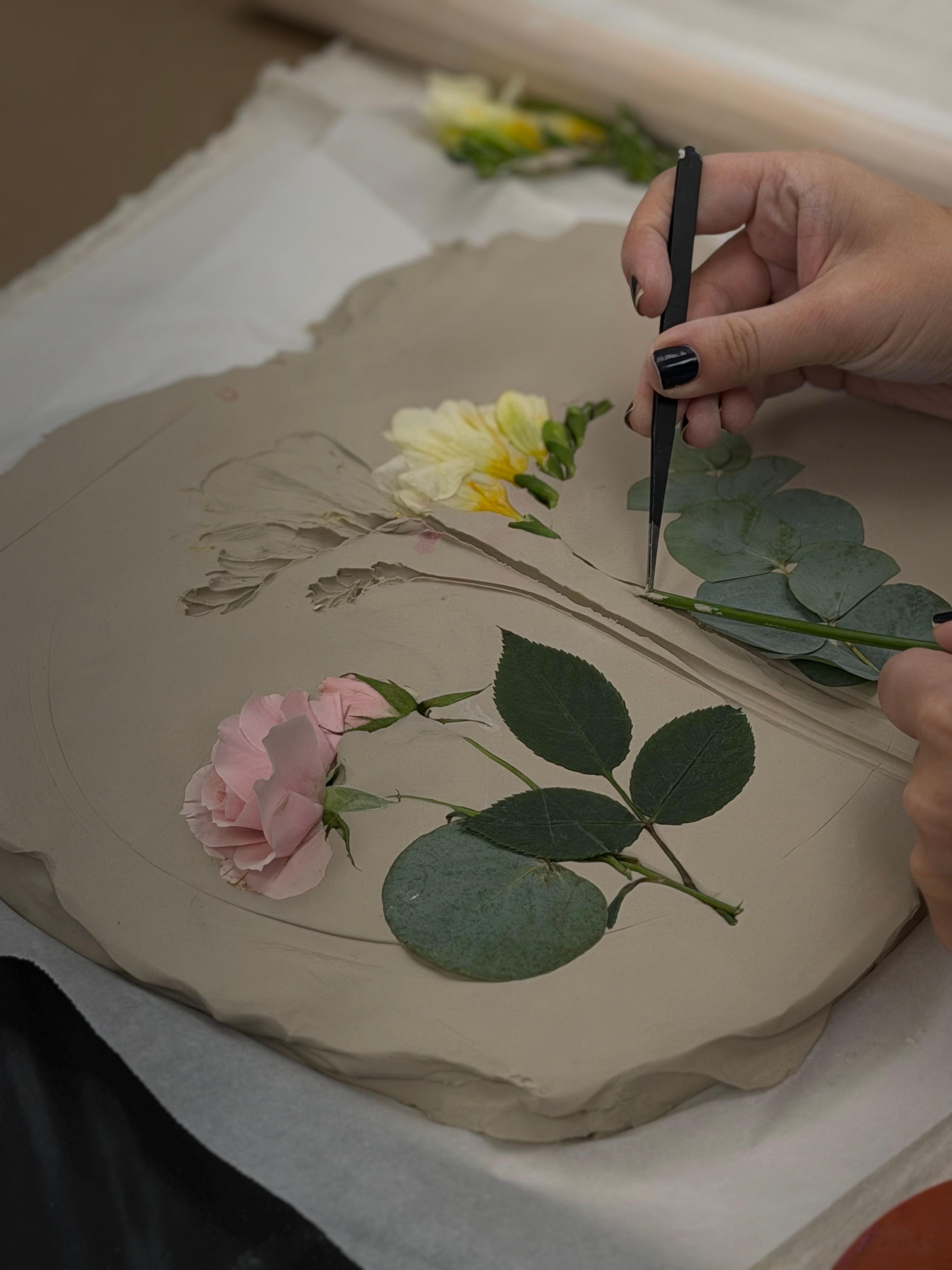Creative Floral Pattern Pressing on Clay Surface · Free Stock Photo
