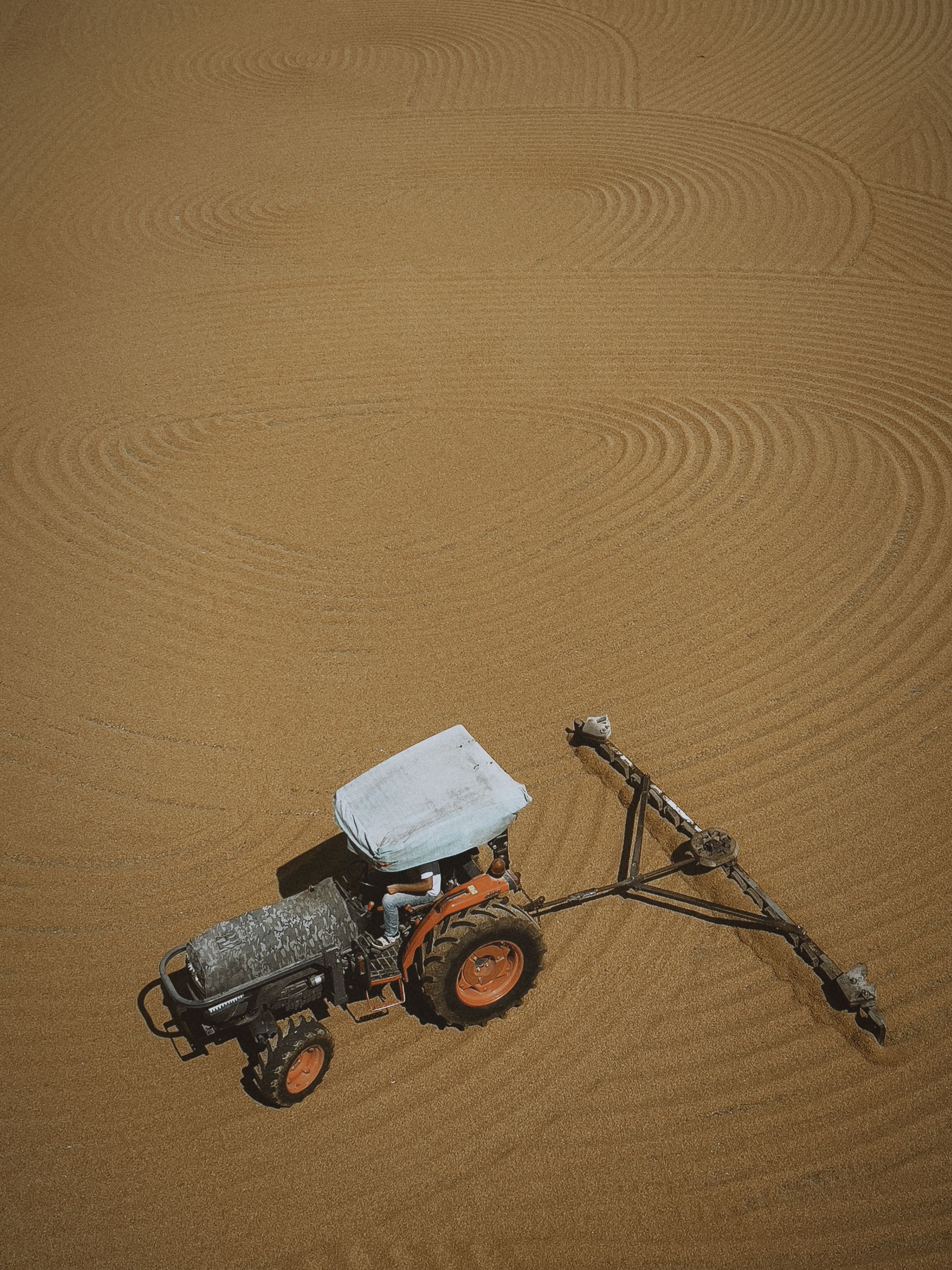 Aerial View of Tractor Creating Patterns in Sand · Free Stock Photo