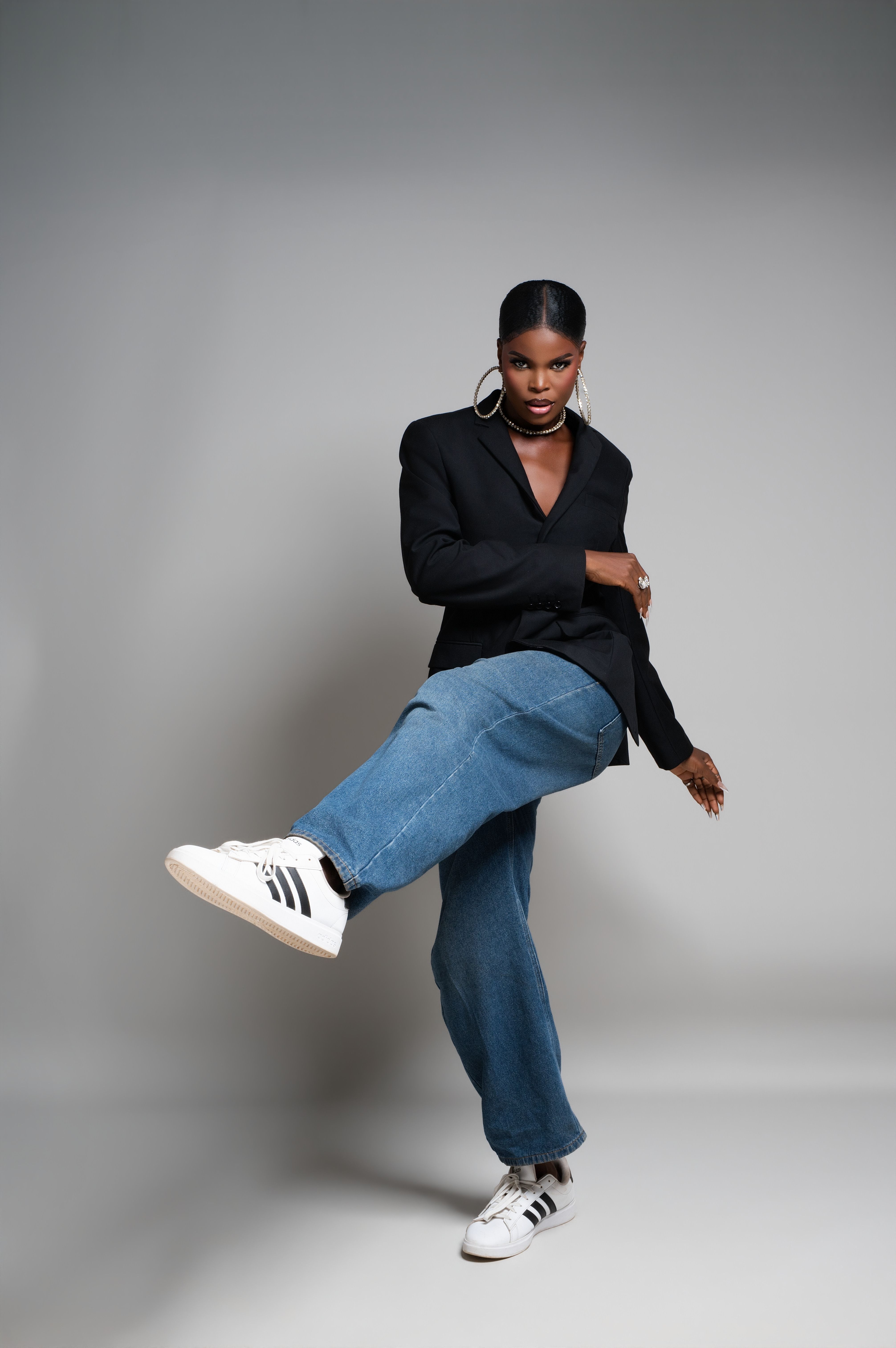 Stylish Dance Pose in Denim Jeans and Sneakers · Free Stock Photo