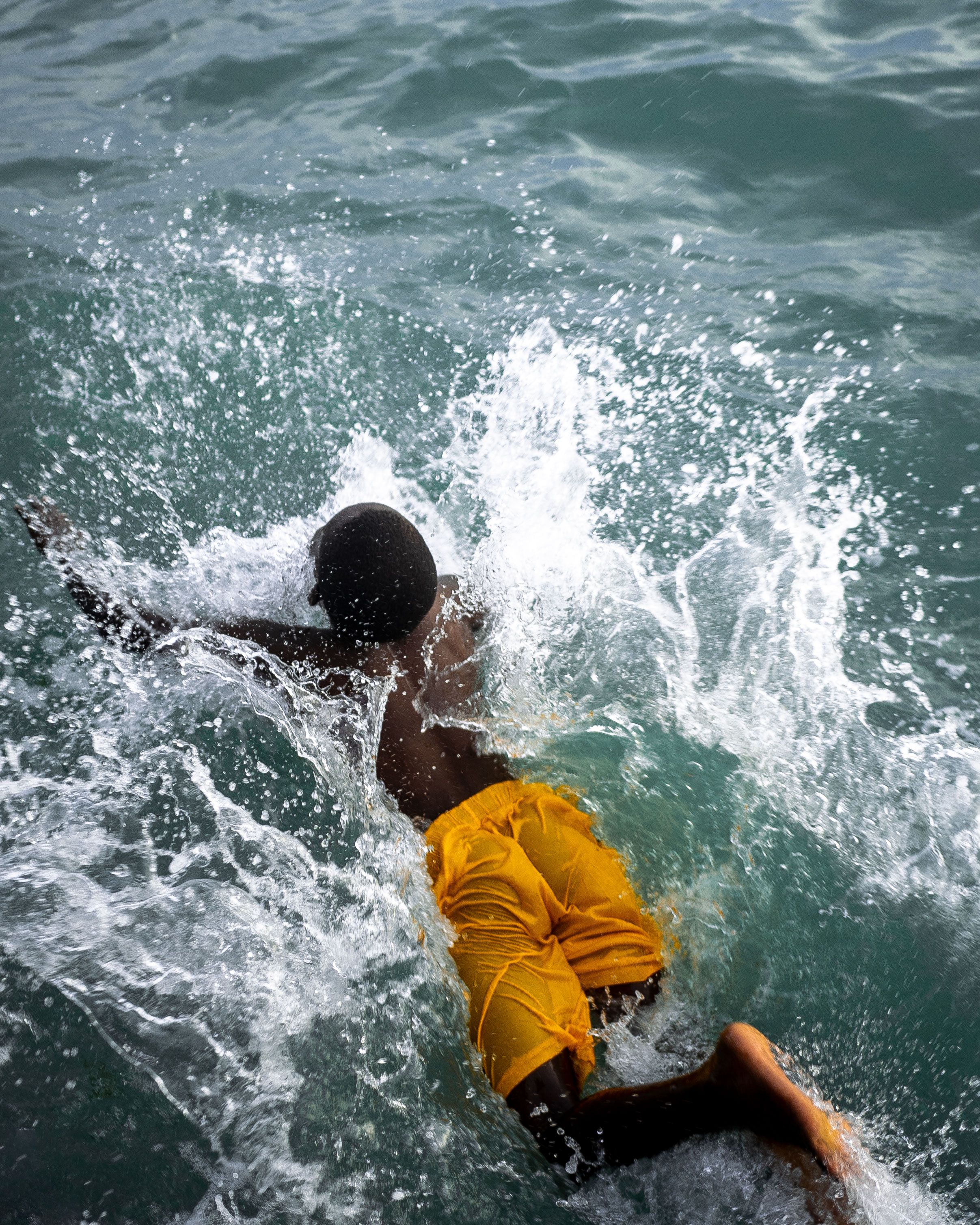 Child Playing in Ocean Waves in Zanzibar · Free Stock Photo