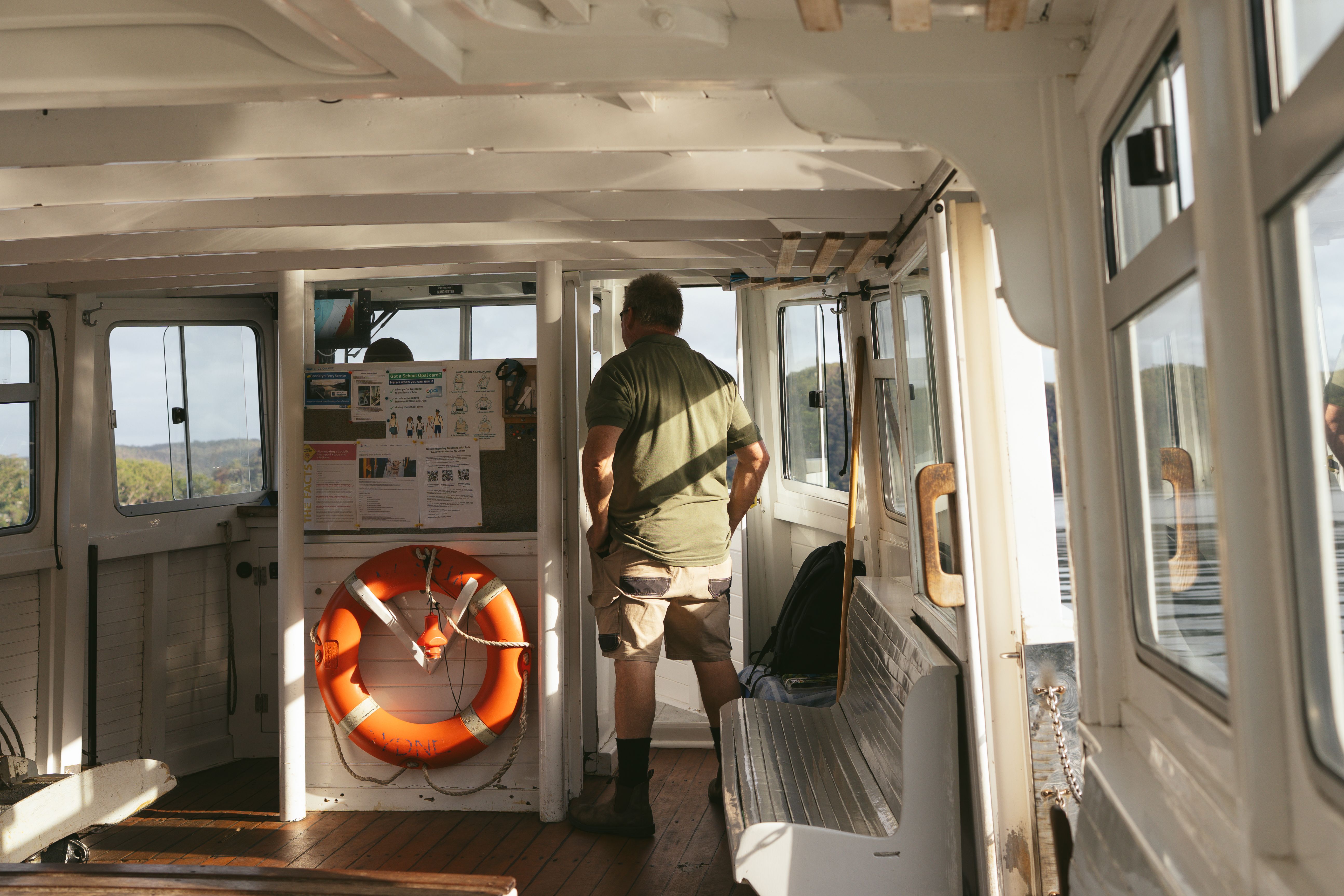 Man Navigating Small Boat on a Sunny Day · Free Stock Photo