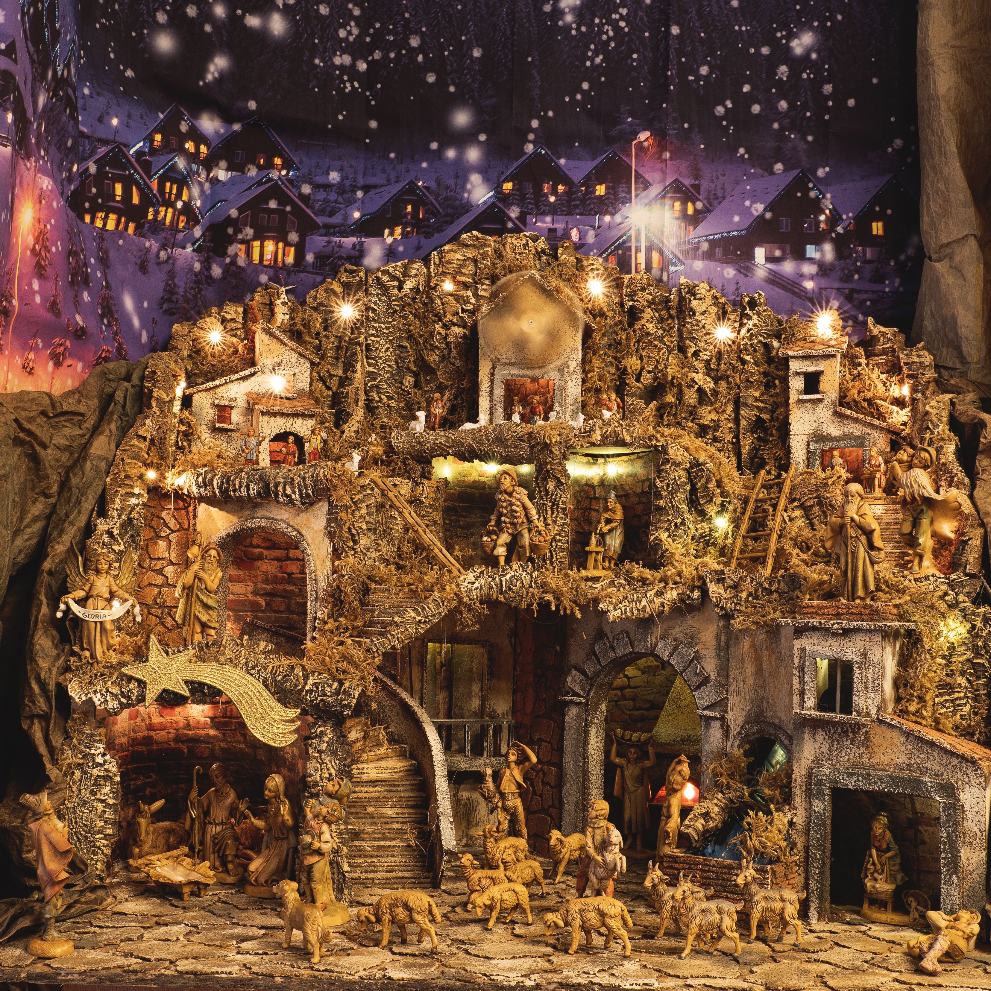 Beautifully Lit Nativity Scene with Snowy Village · Free Stock Photo