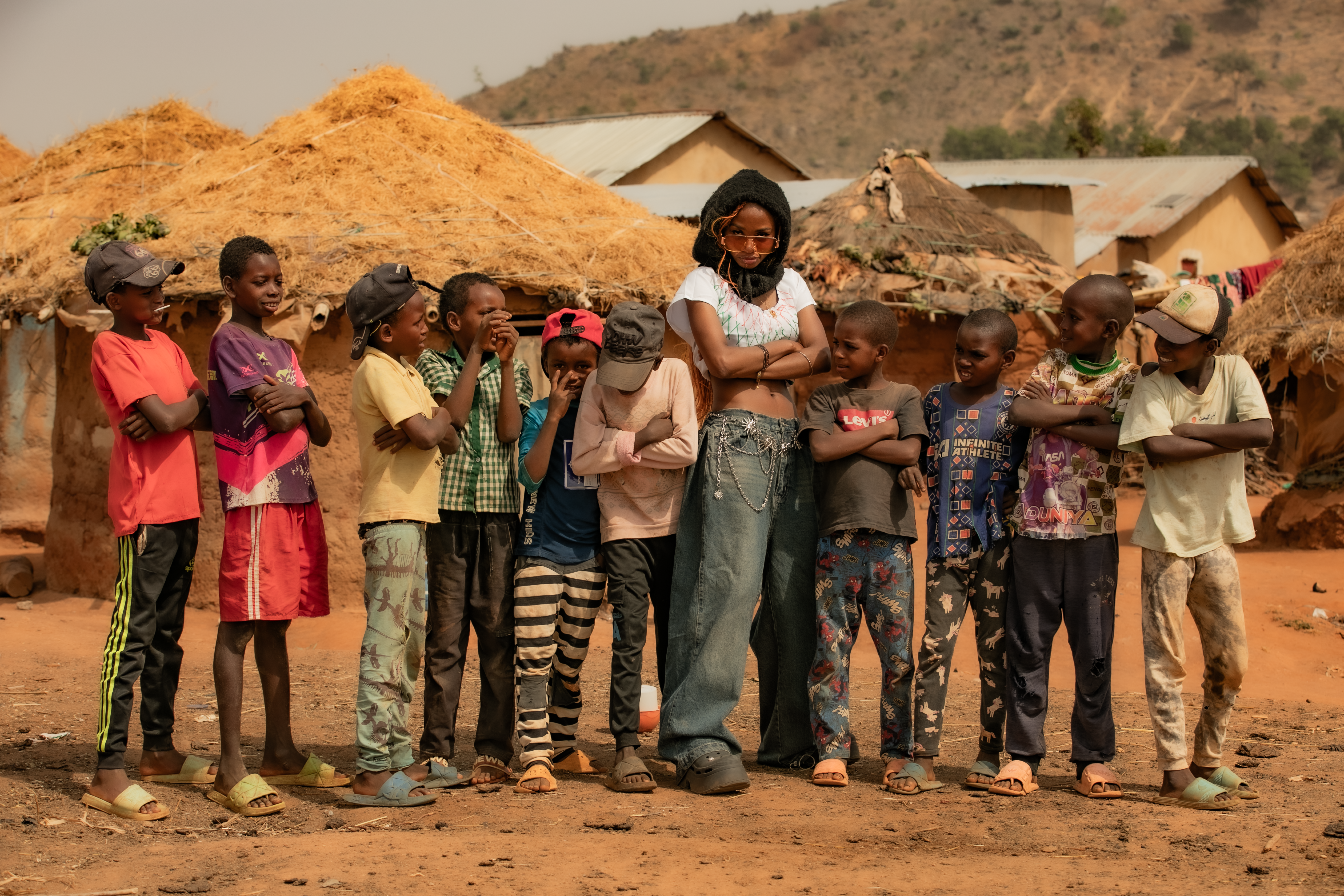Group of Children with Woman in Rural Village Setting · Free Stock Photo