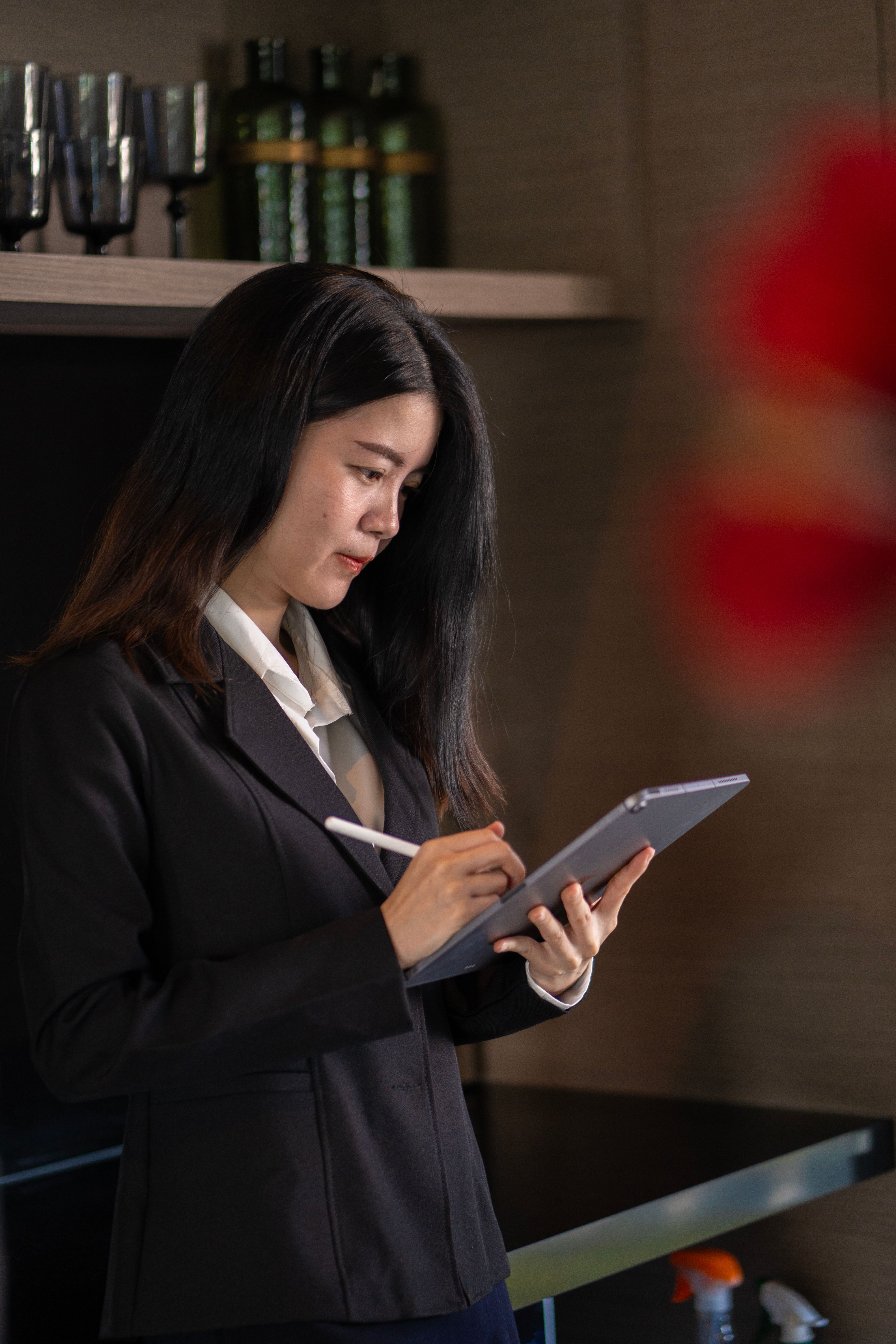 Female Receptionist Holding Papers and Passport · Free Stock Photo