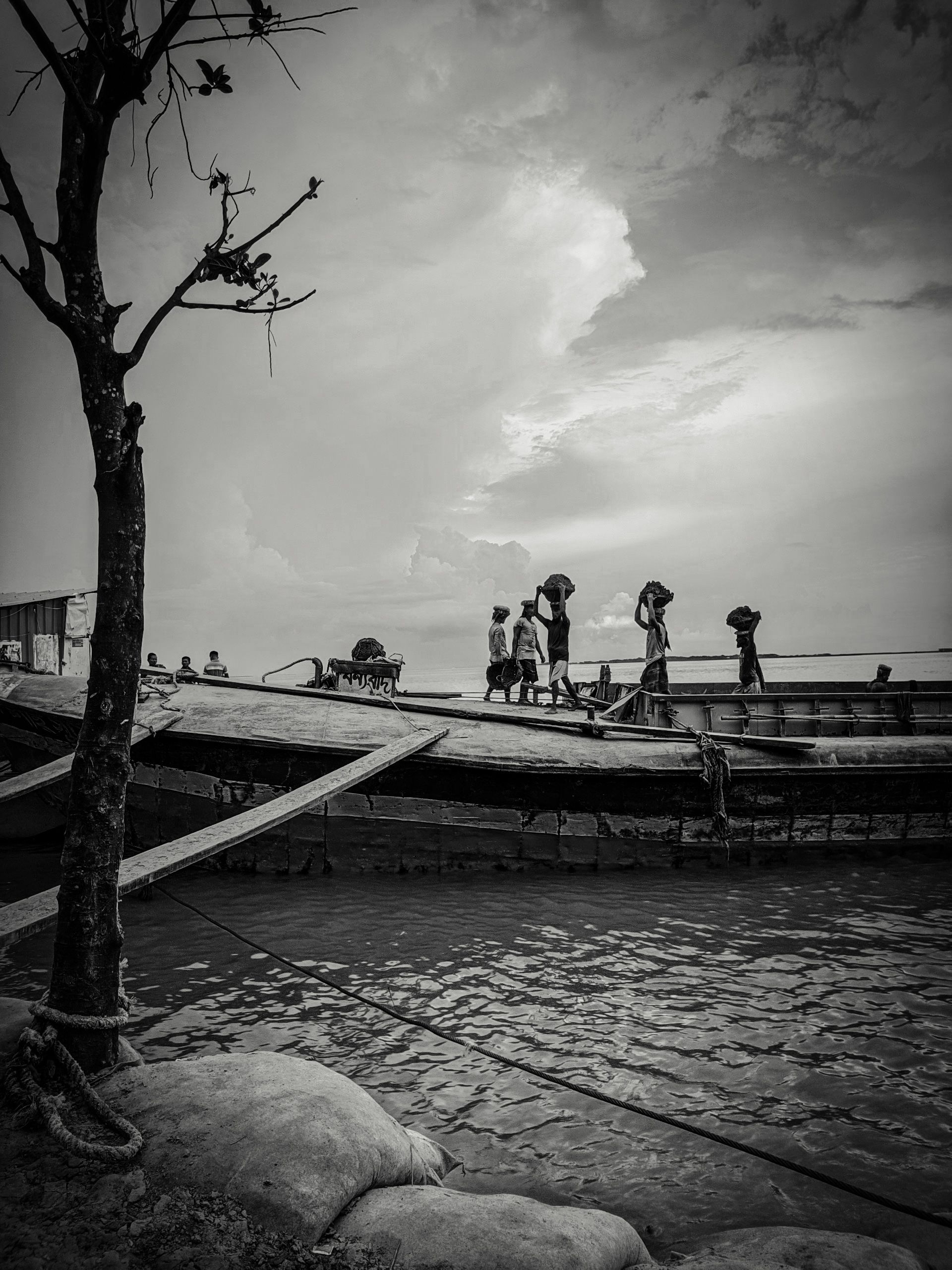 Black and White River Scene with Workers on Boats · Free Stock Photo
