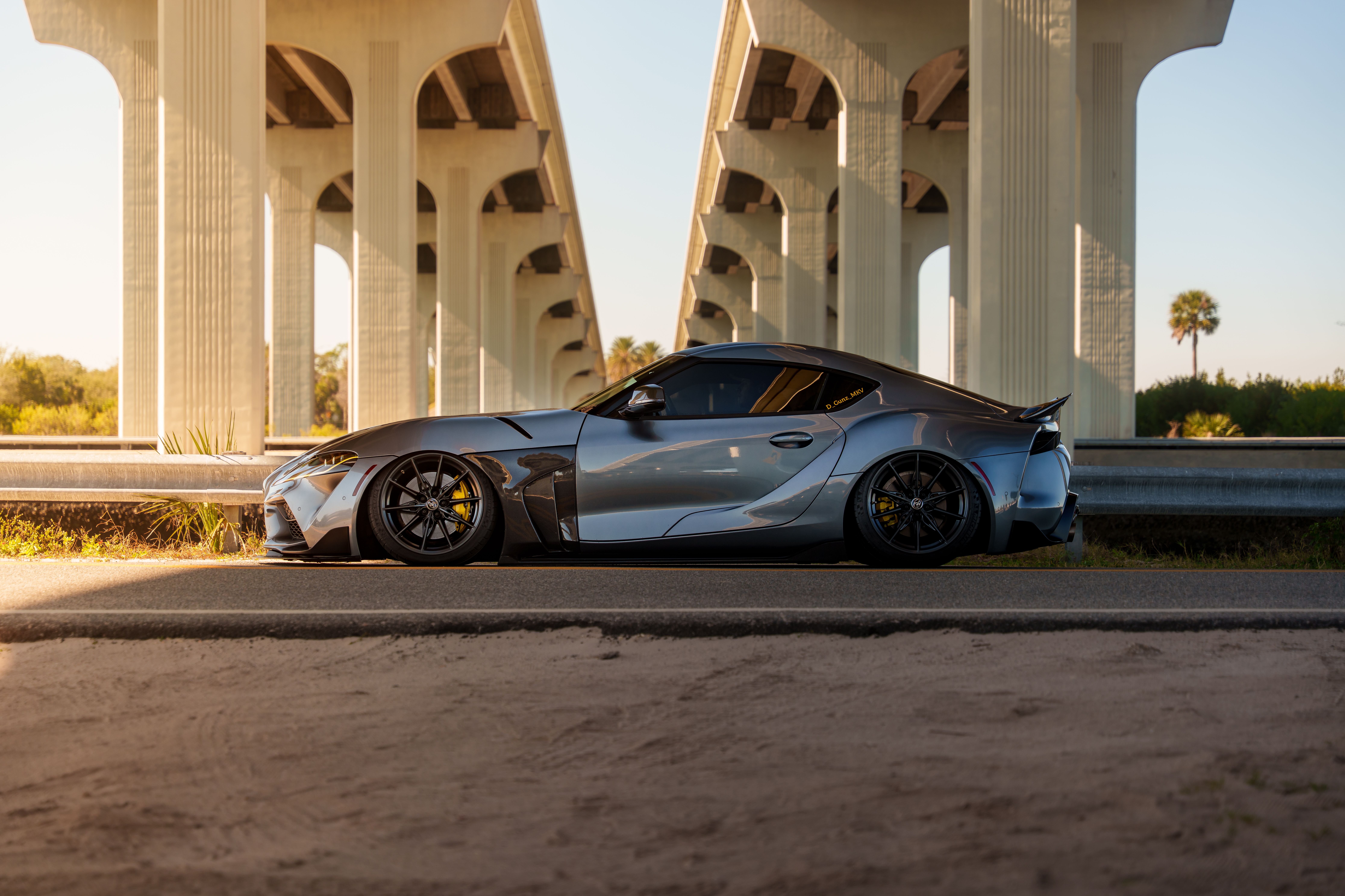 Sleek Sports Car Under Modern Bridge · Free Stock Photo