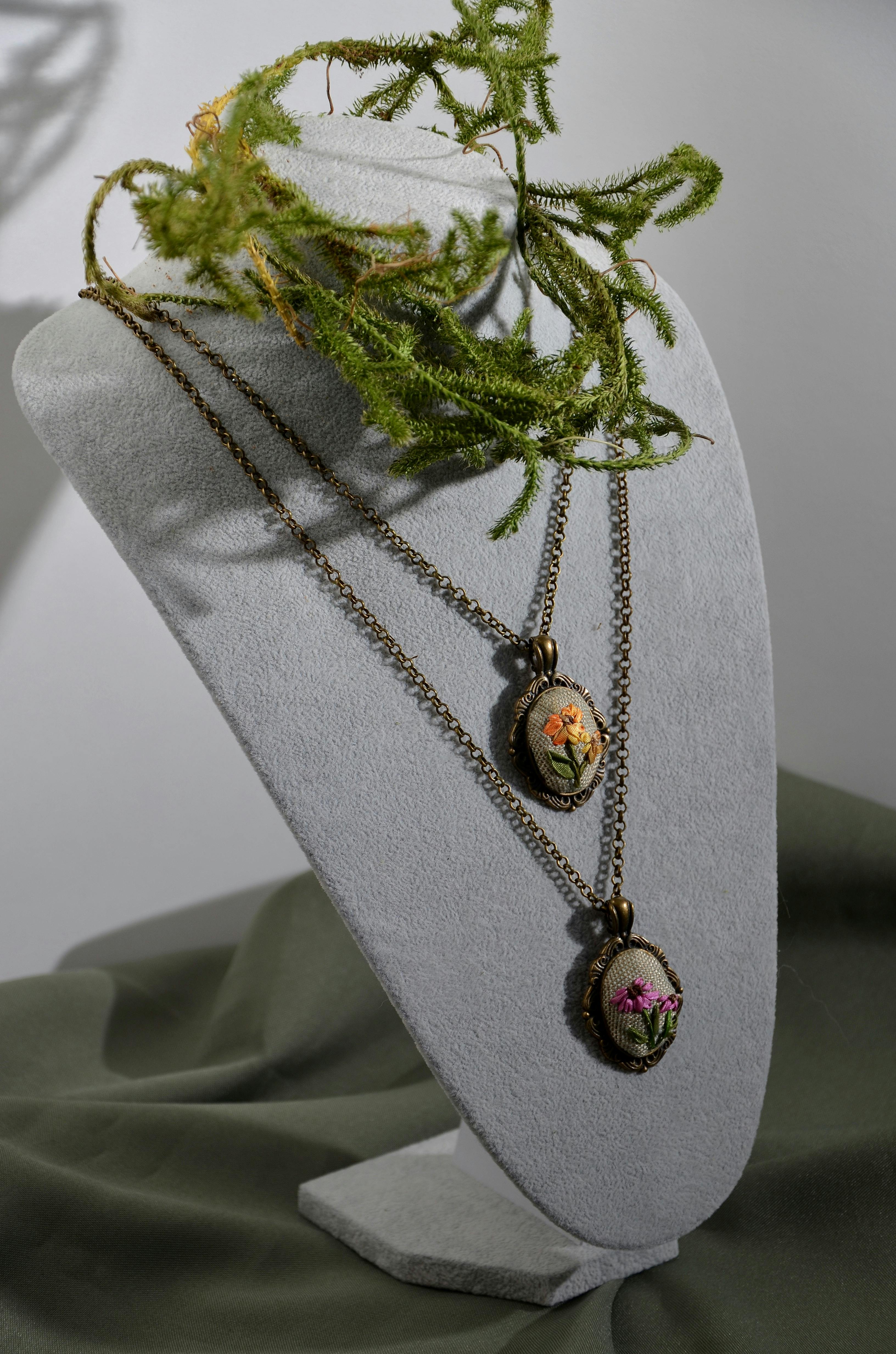 Vintage Floral Locket Necklaces on Display · Free Stock Photo