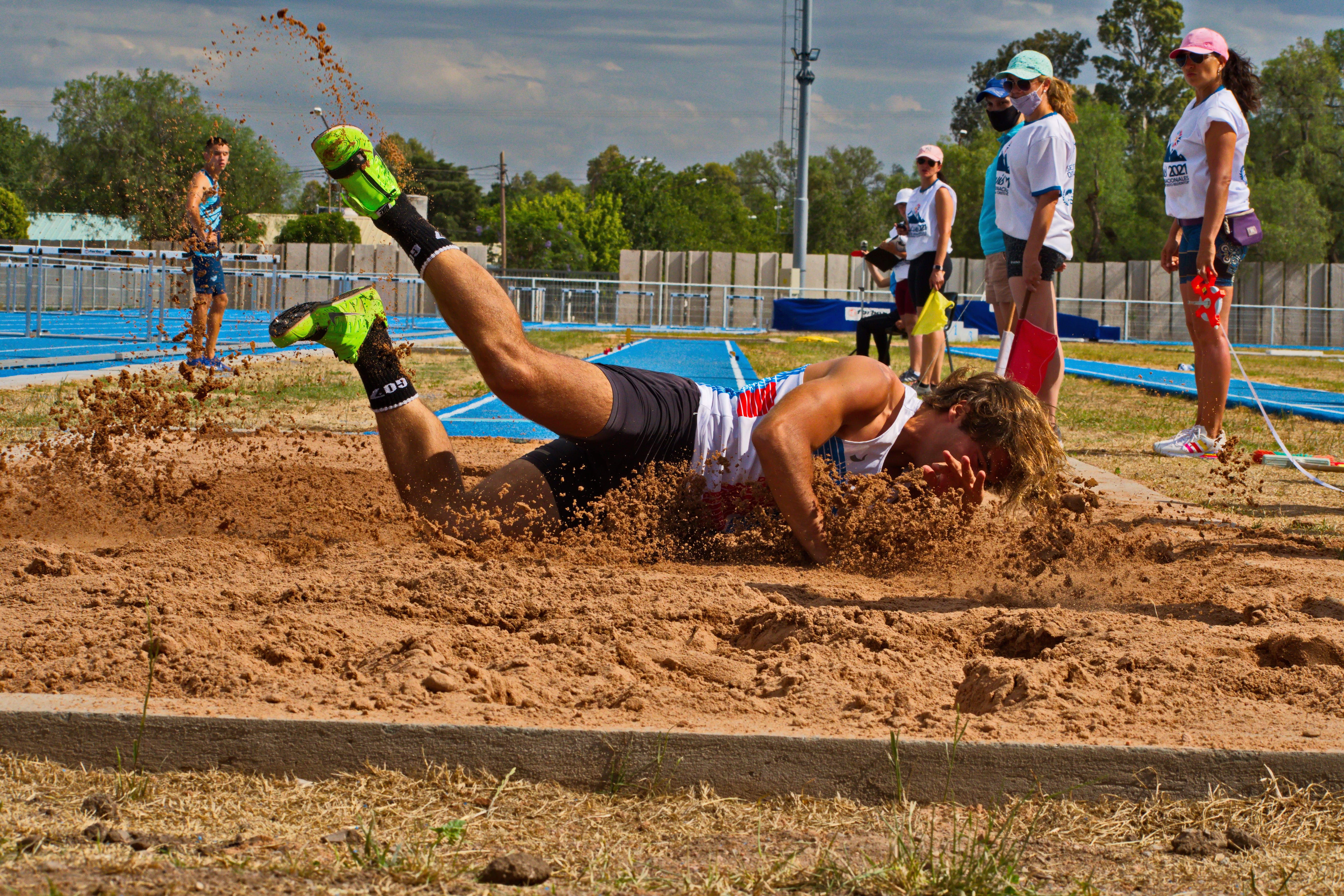 Long Jump Athlete Landing in Sand Pit · Free Stock Photo