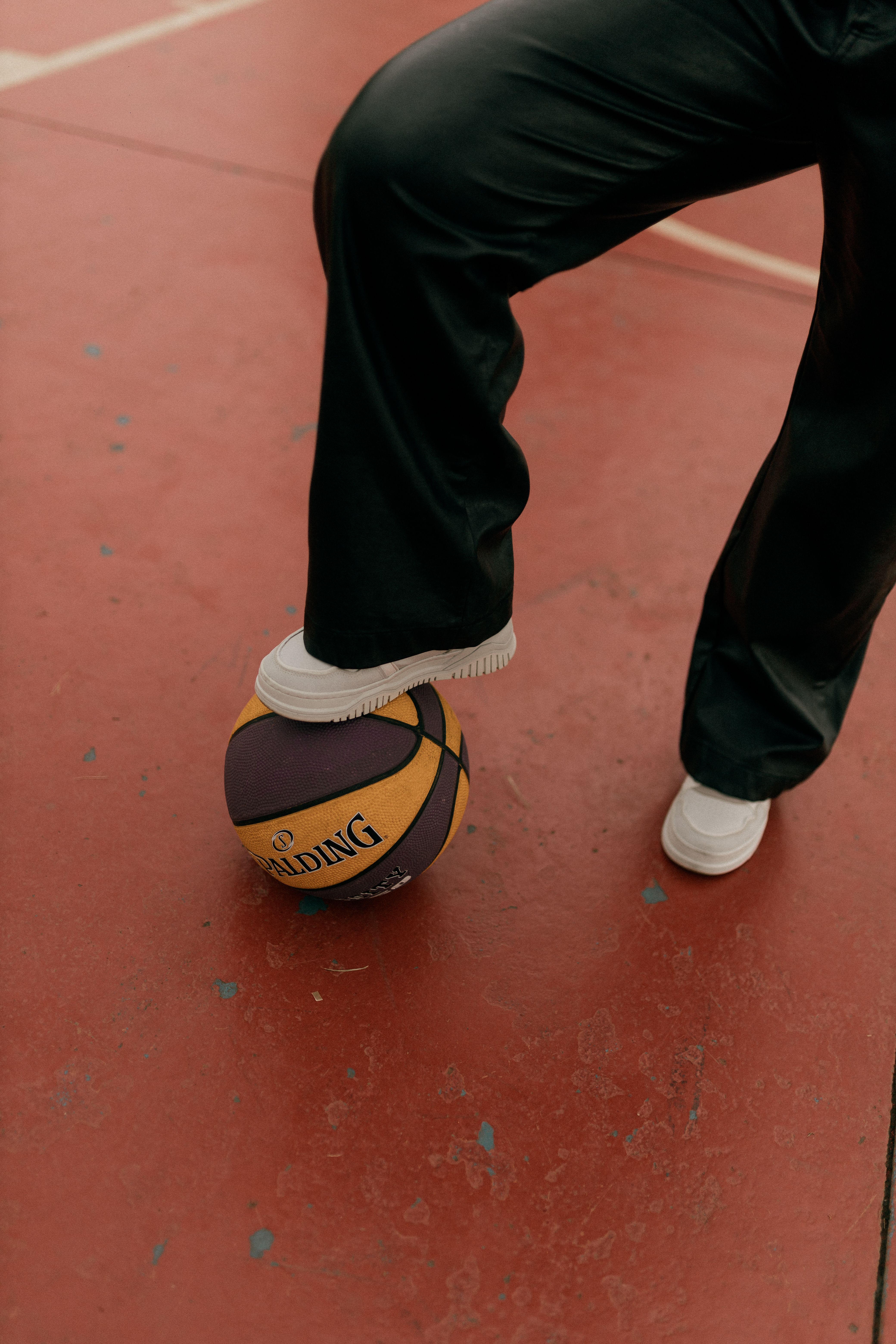 Person Balancing Soccer Ball on Outdoor Court · Free Stock Photo