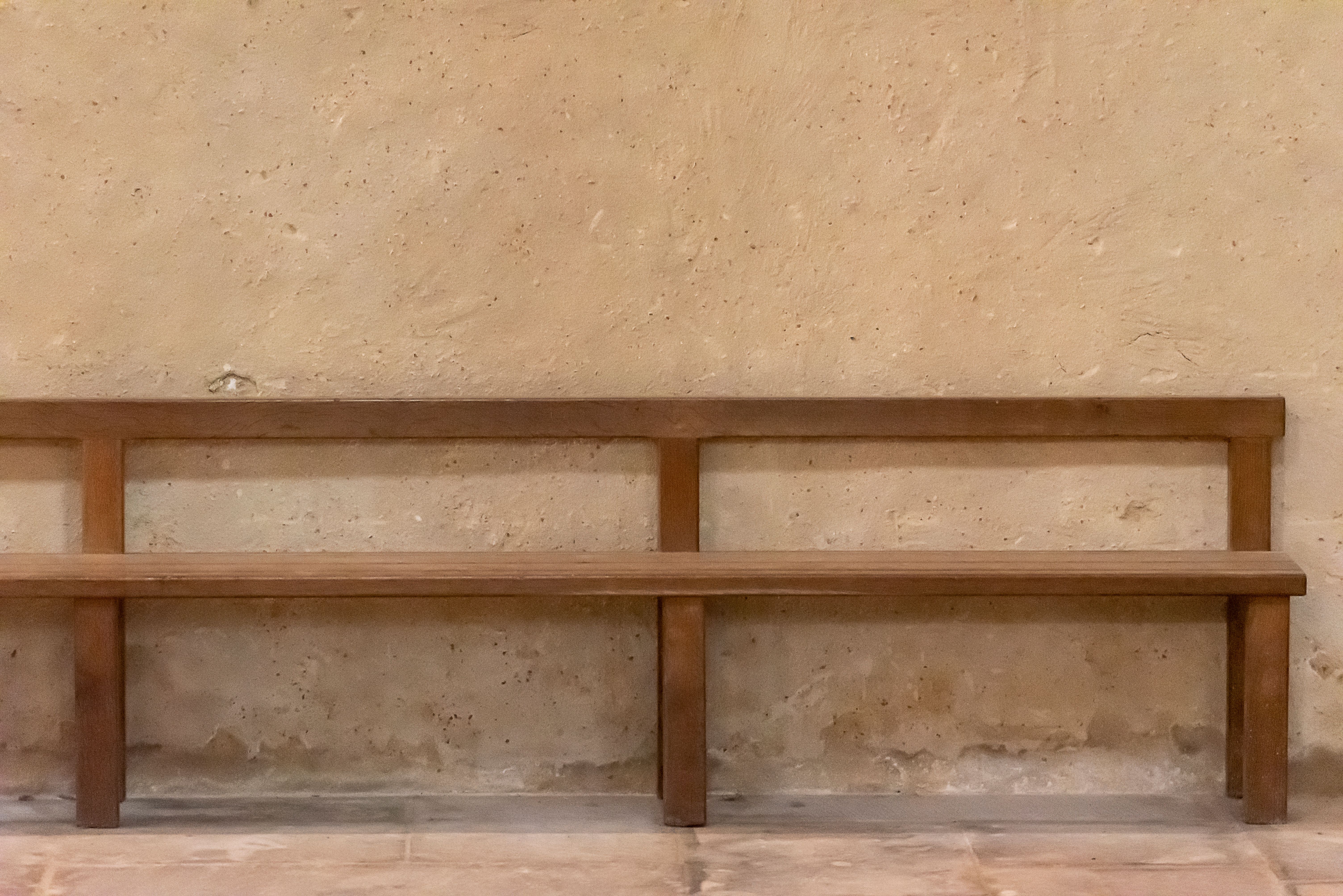 Minimalist Wooden Bench Against Wall · Free Stock Photo