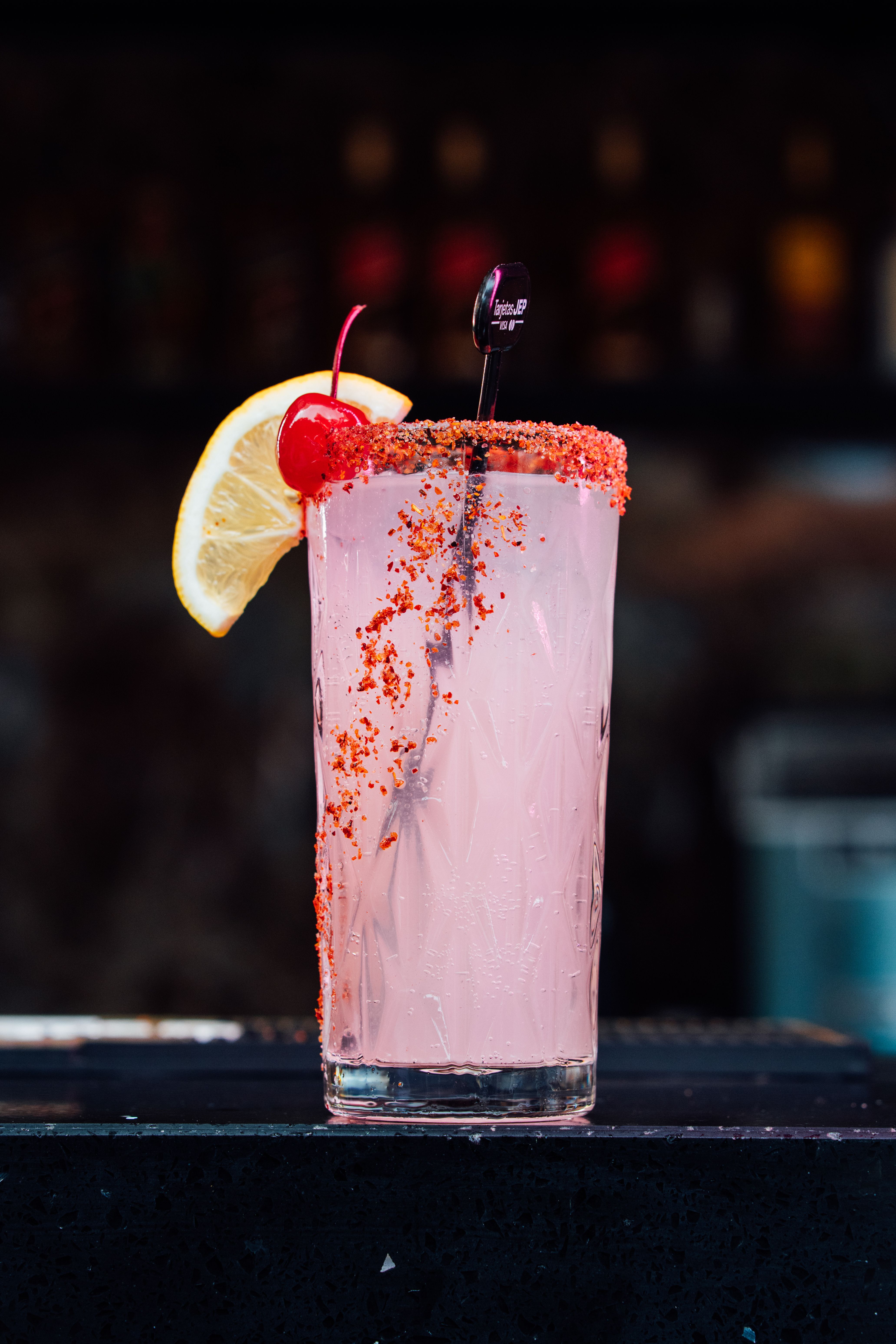 Vibrant Pink Cocktail with Lemon and Cherry Garnish · Free Stock Photo