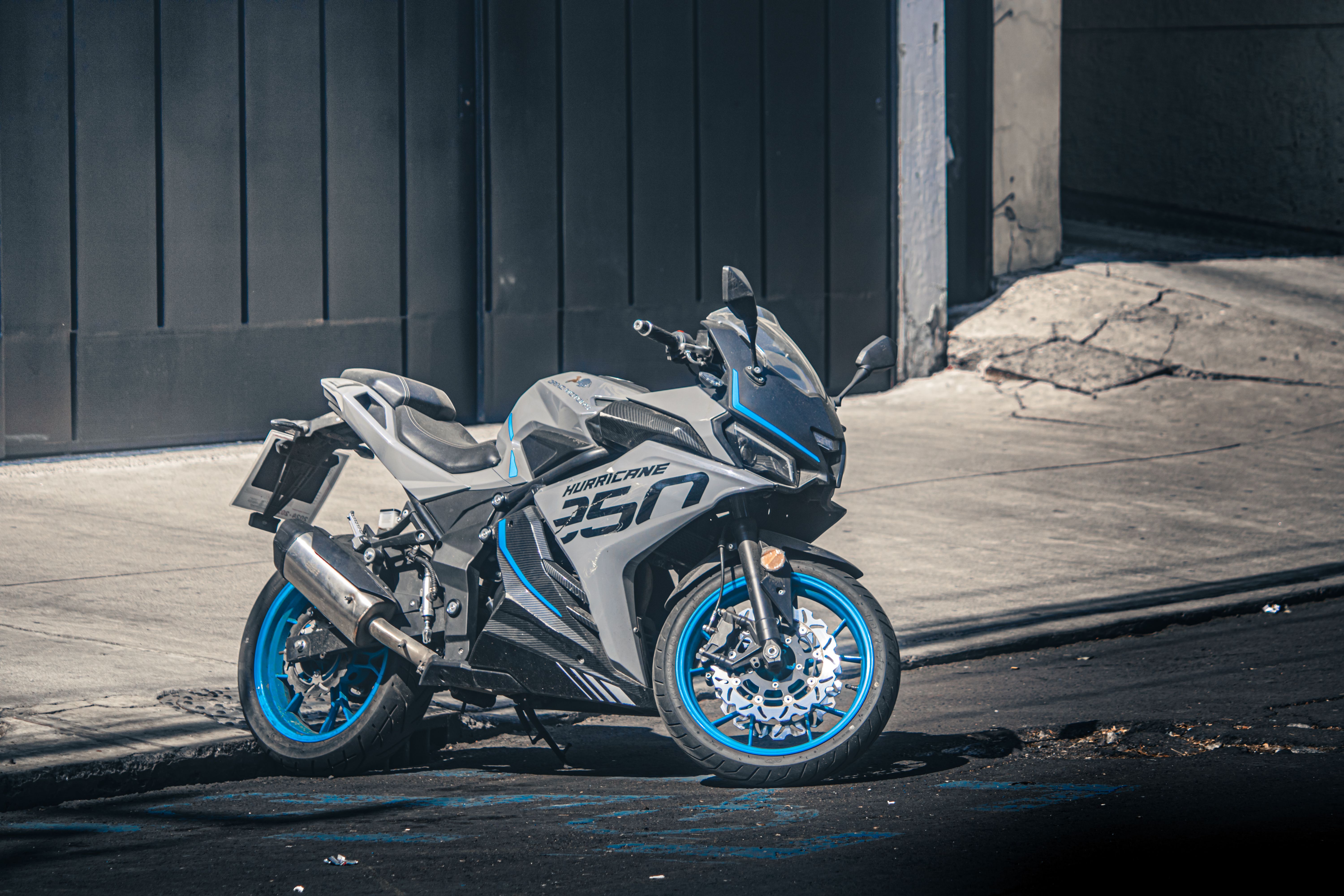 Modern Blue and White Motorcycle on City Sidewalk · Free Stock Photo